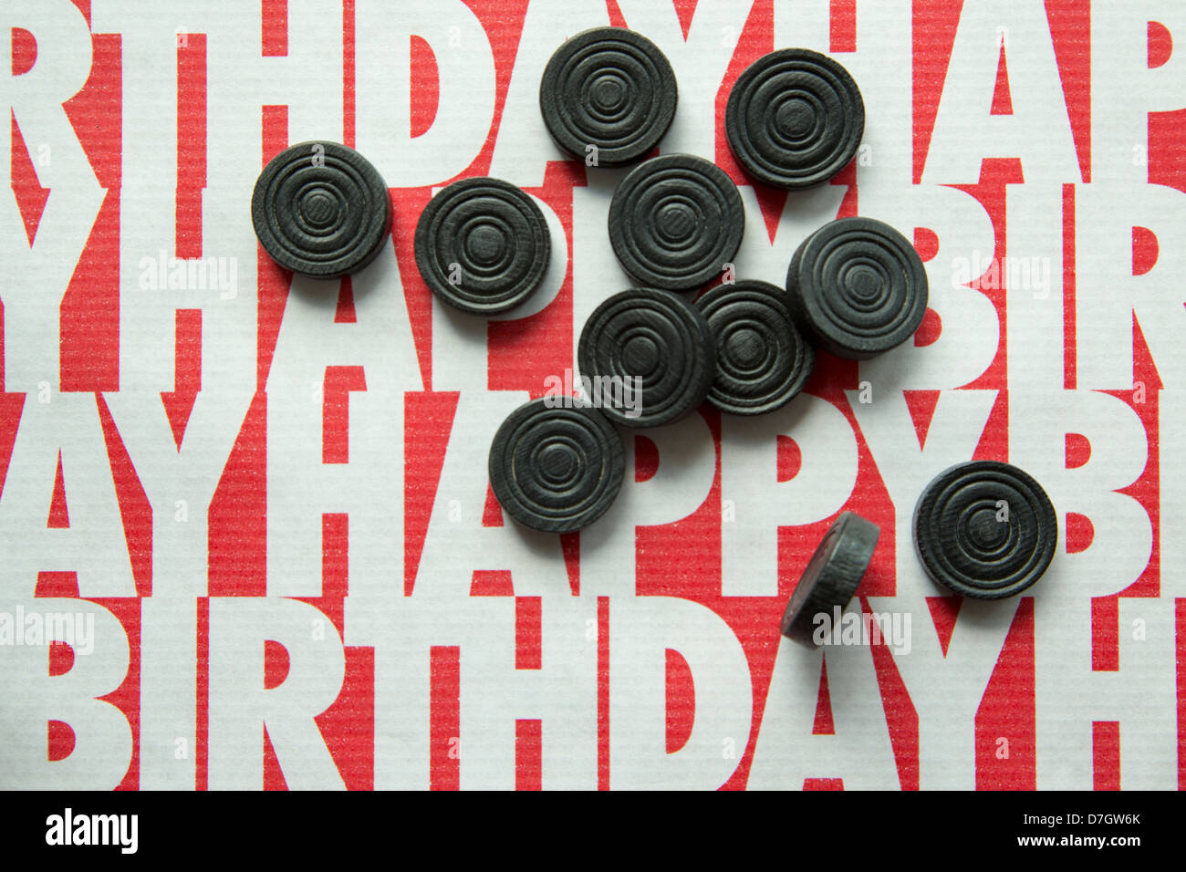 A shot of some 'happy birthday' wrapping paper with some checkers in ...