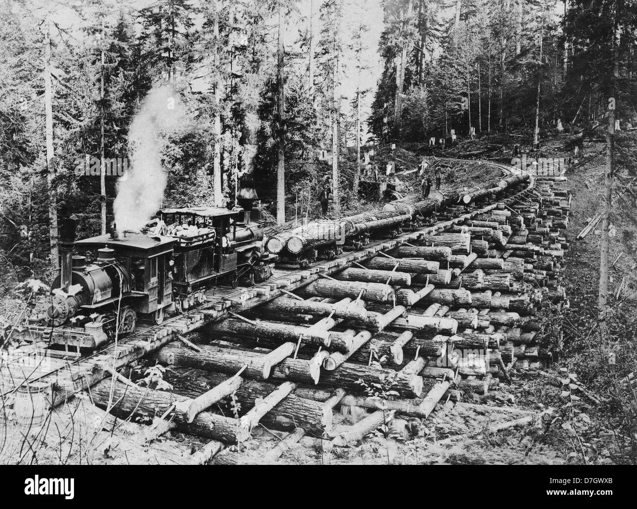 Locomotive pulling railroad cars with logs over a crib trestle Stock ...