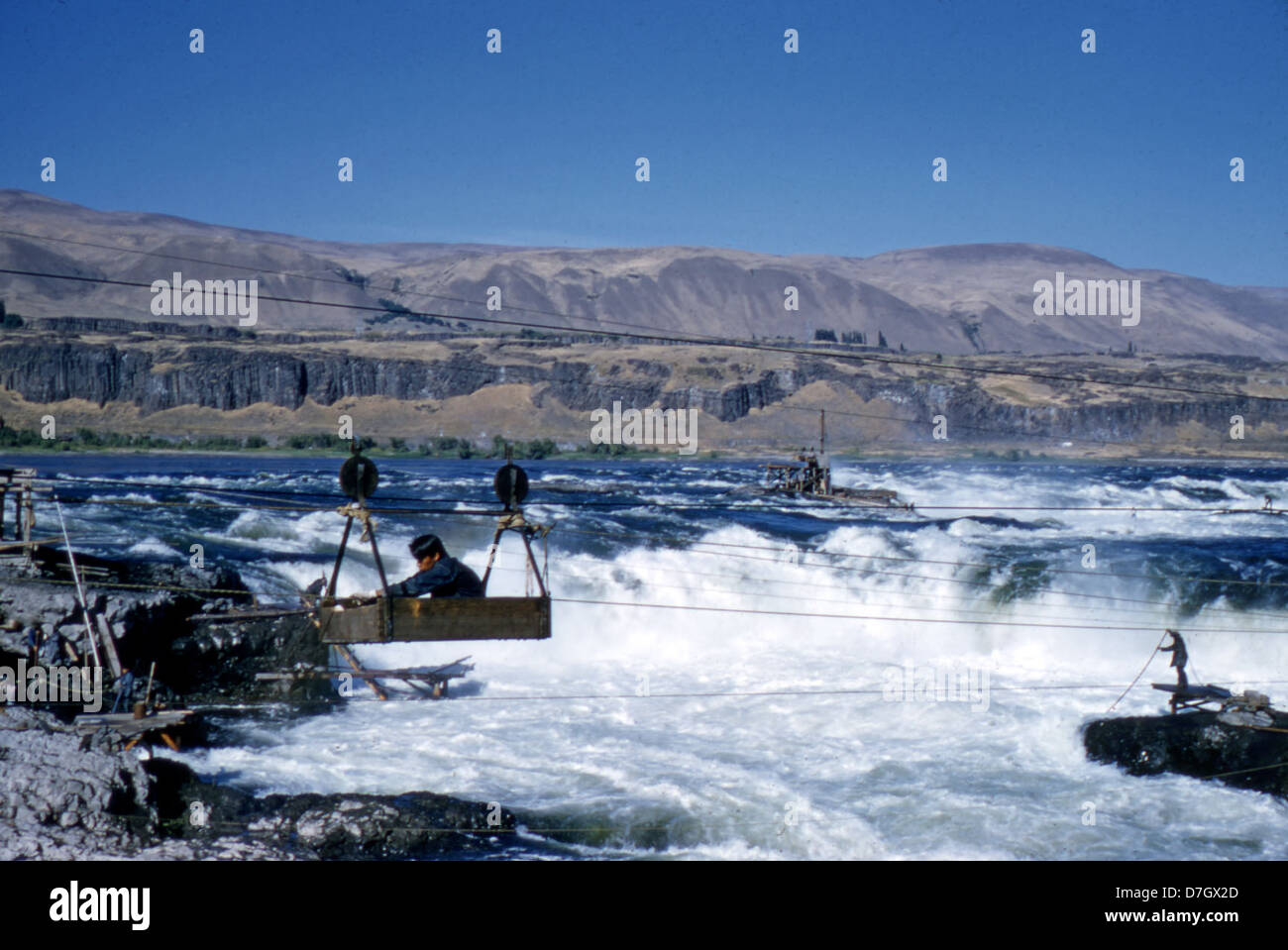 This historical photograph captures fishermen at Celilo Falls on the ...