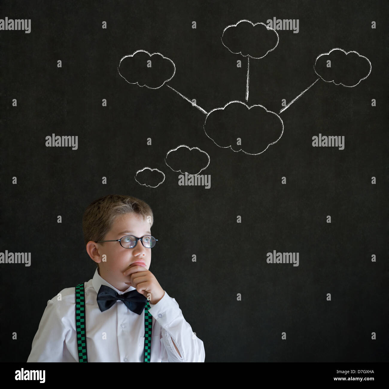 Thinking boy dressed up as business man with strategy thought chalk ...