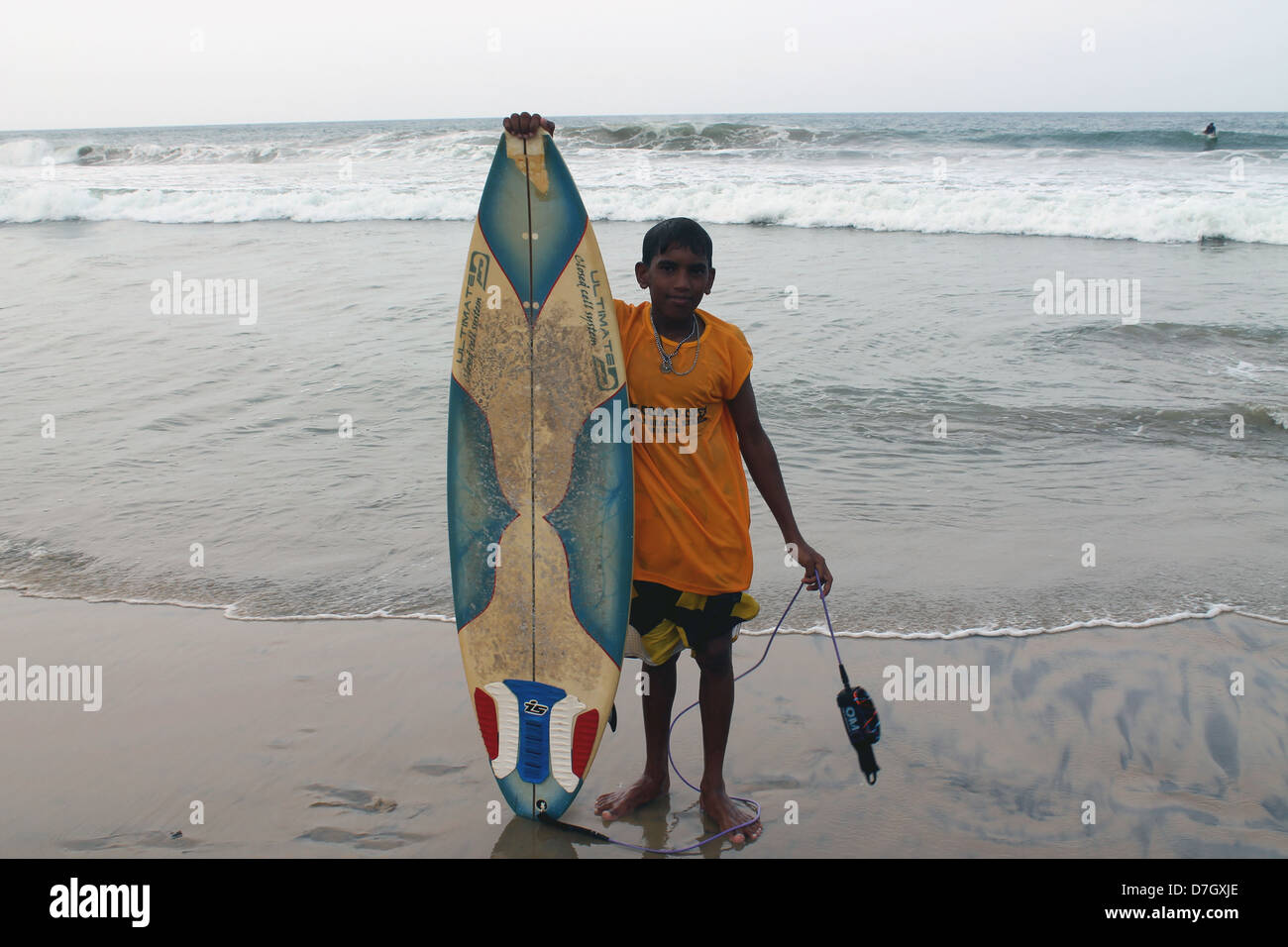 A child surfer posing for photograph with his surfing board Stock Photo ...