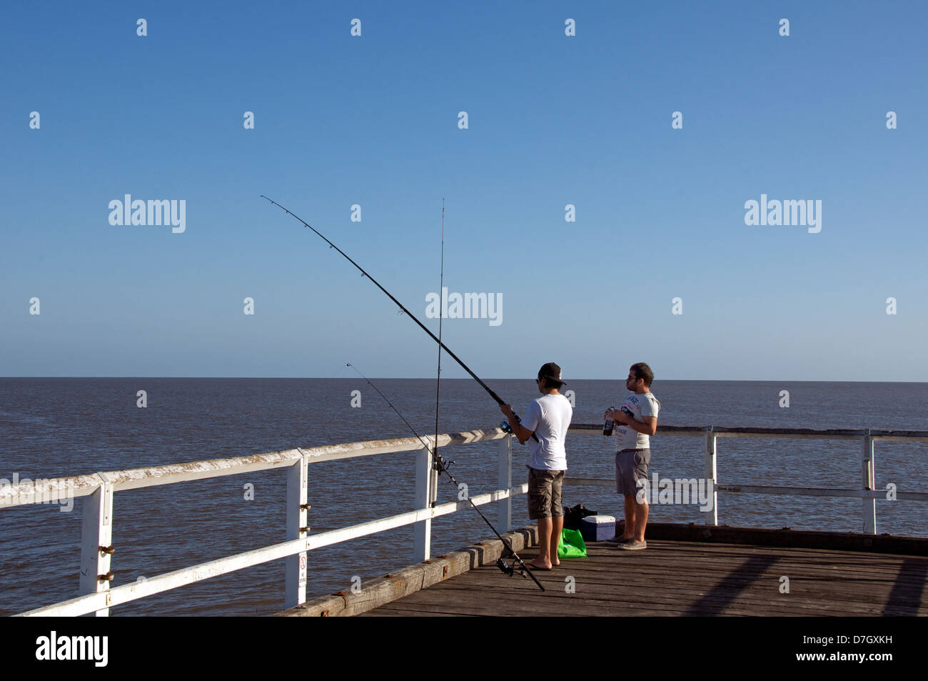 Two men fishing from Urangan Pier Hervey Bay Queensland Australia Stock ...