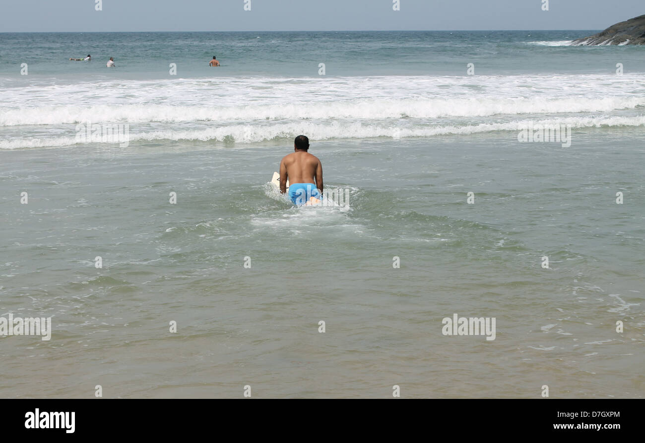 A surfer jumping into sea with surfing board Stock Photo - Alamy