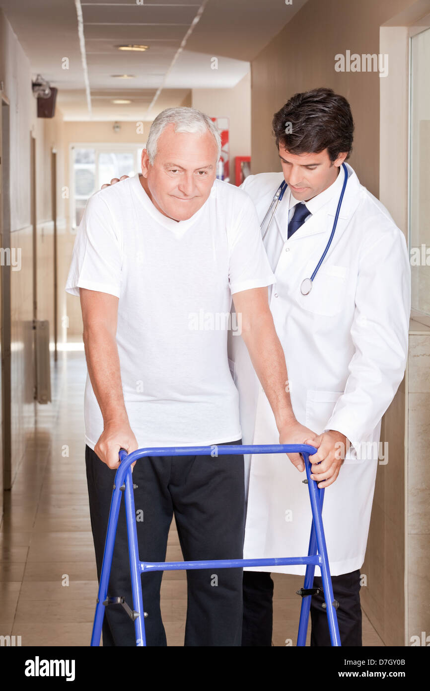Doctor helping Patient use Walker Stock Photo - Alamy