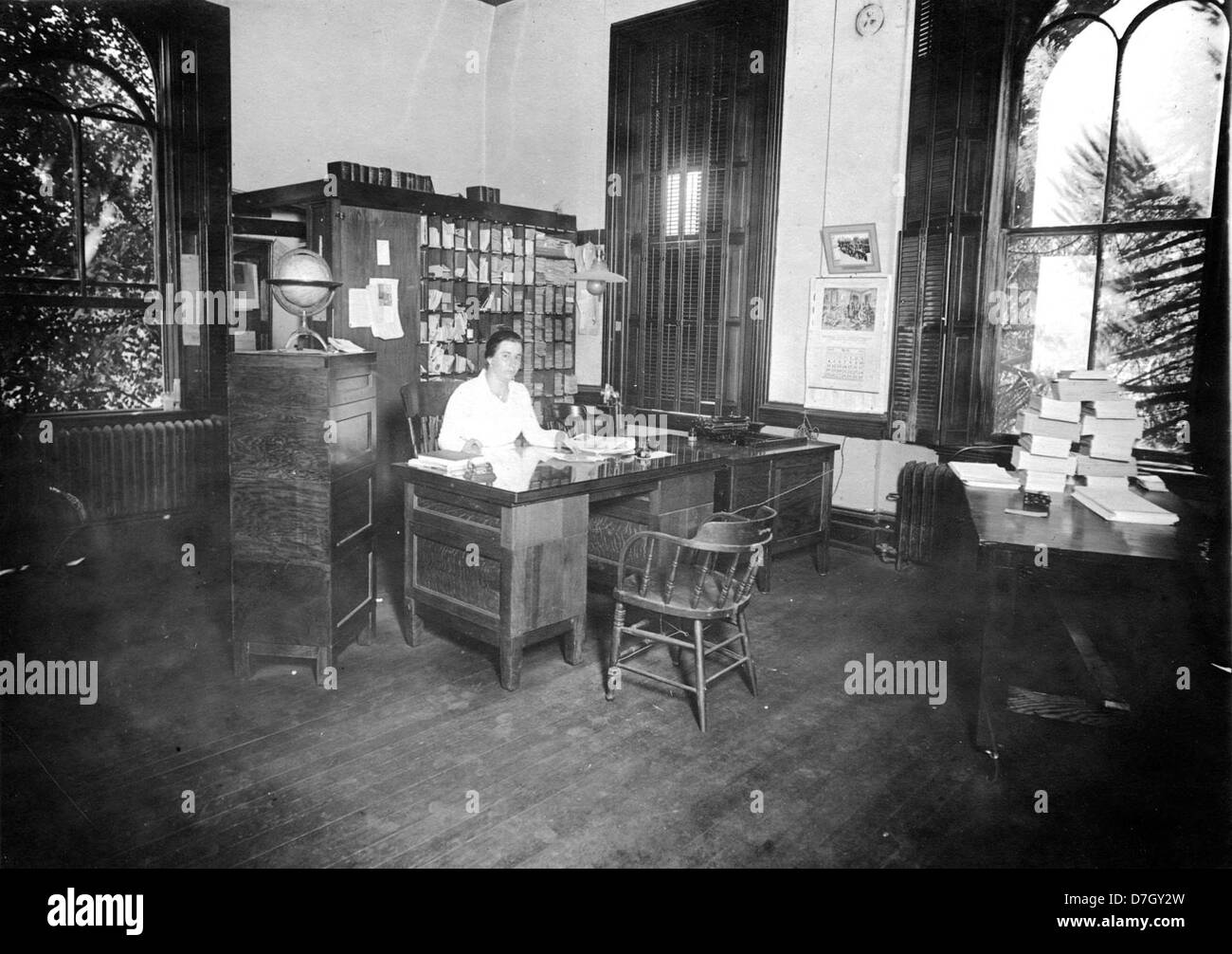 This photograph depicts the office of a lumber company, capturing a ...