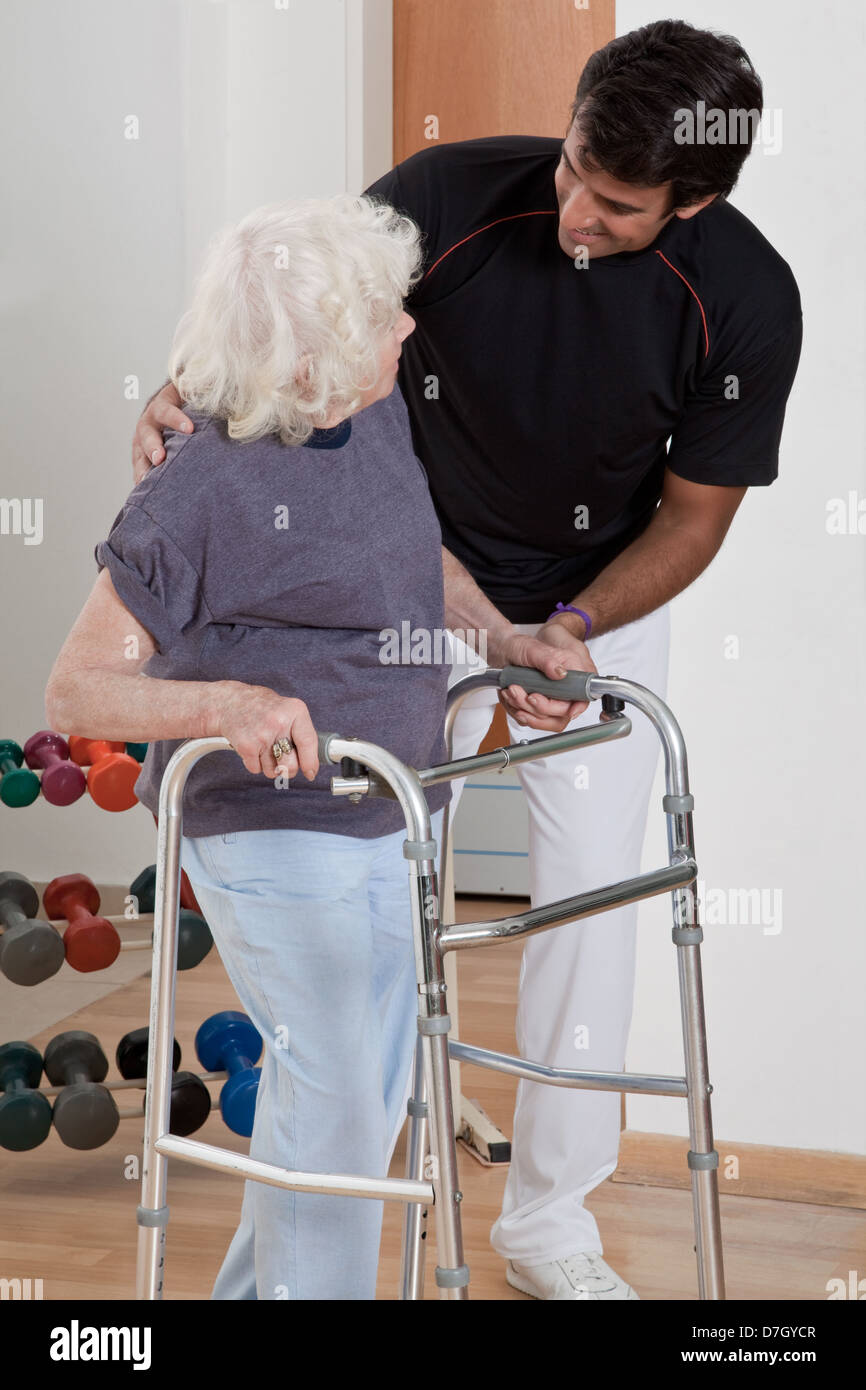 Therapist helping Patient use Walker Stock Photo - Alamy