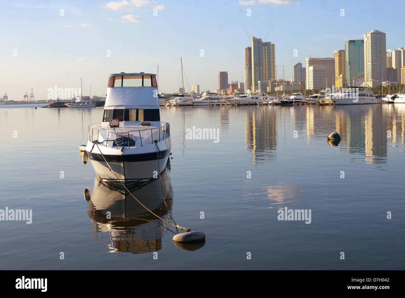 manila bay city scape with yachts and luxury boats on summer afternoon ...