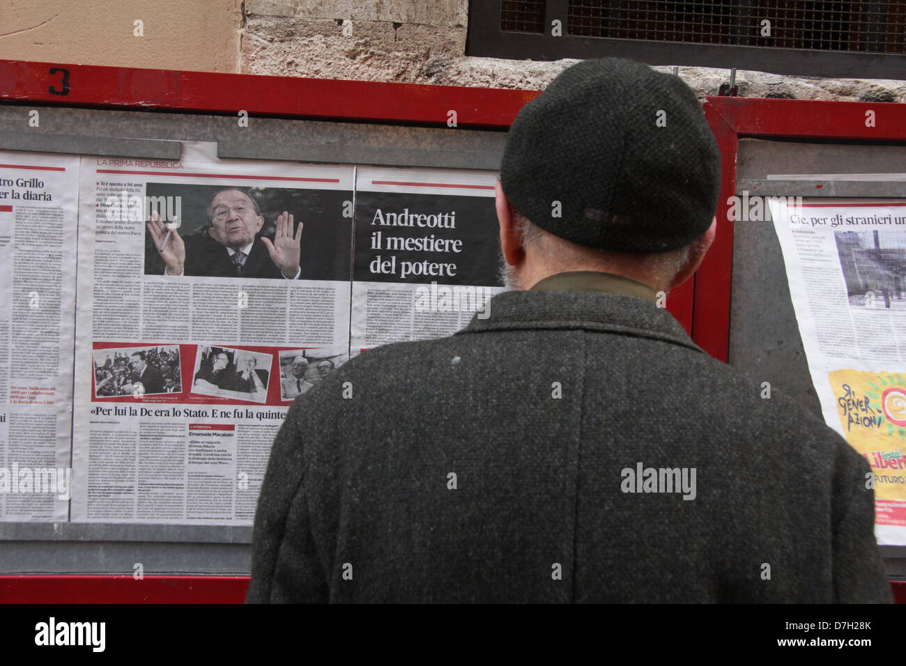 7 May 2013 Old man reading a newspaper article in street in Rome about ...