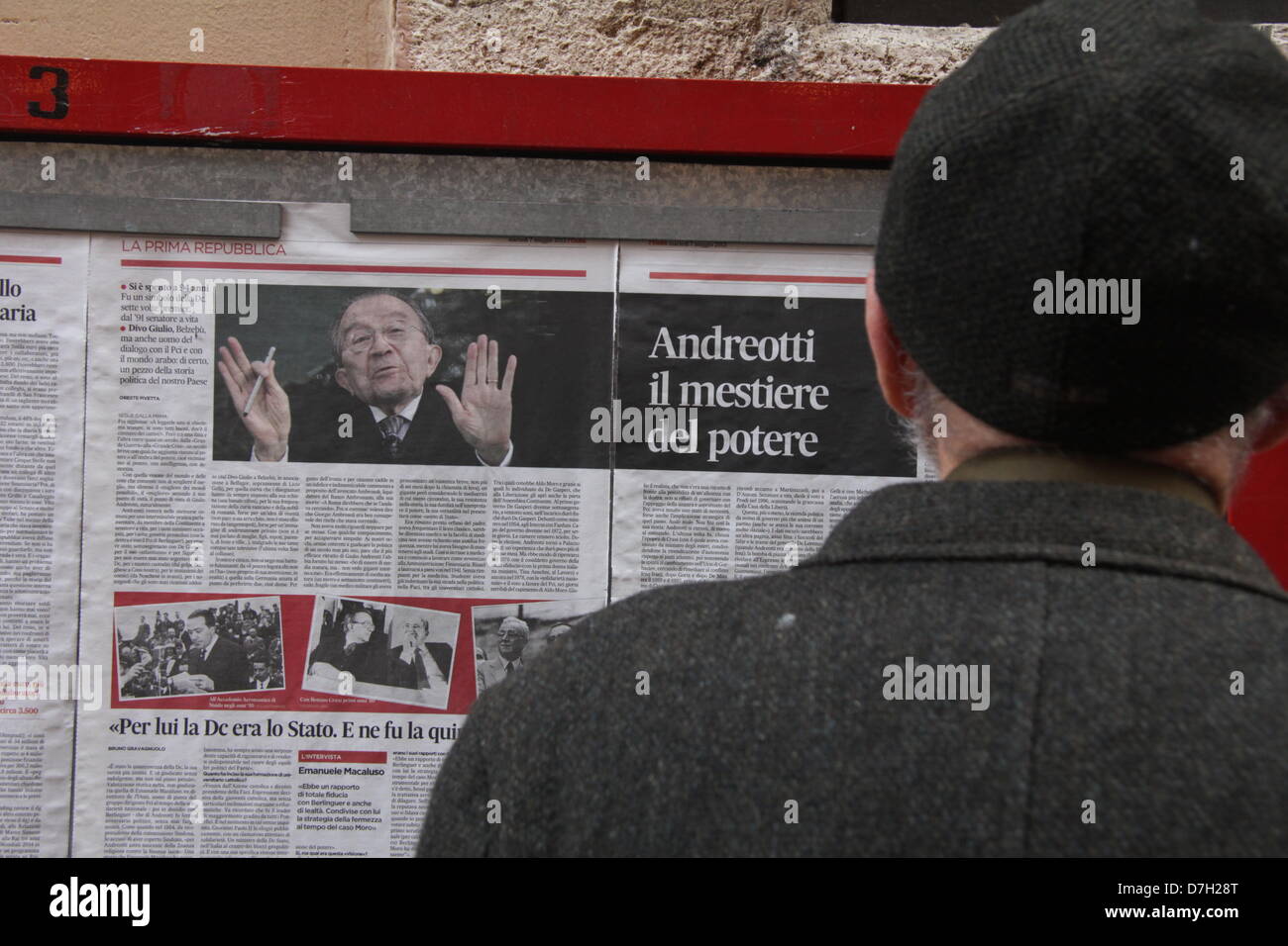 7 May 2013 Old man reading a newspaper article in street in Rome about ...