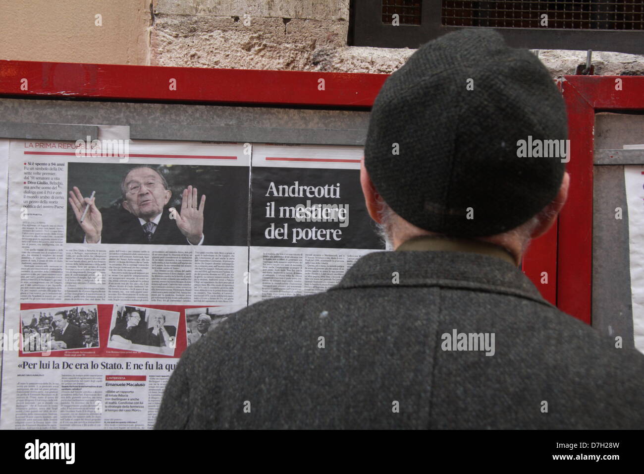 7 May 2013 Old man reading a newspaper article in street in Rome about ...