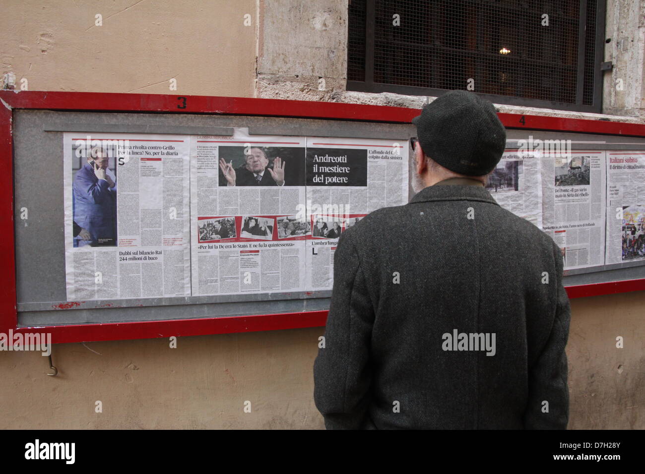 7 May 2013 Old man reading a newspaper article in street in Rome about ...