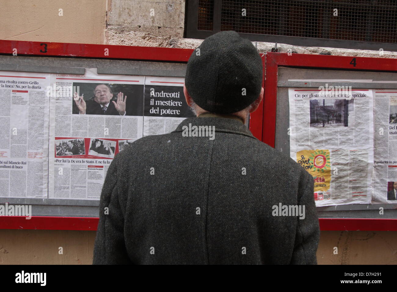 7 May 2013 Old man reading a newspaper article in street in Rome about ...