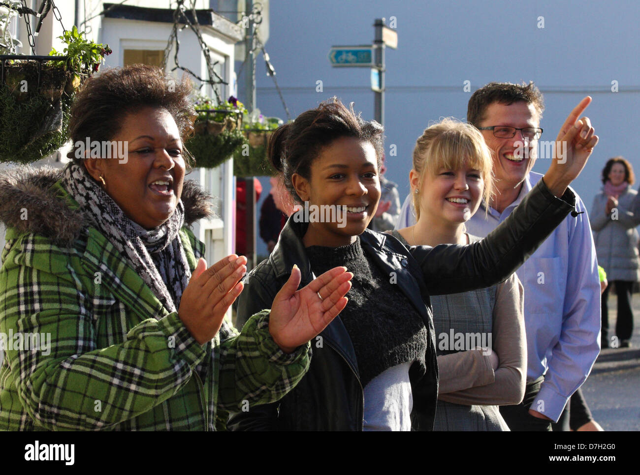Spectators supporting runners in road race Stock Photo - Alamy