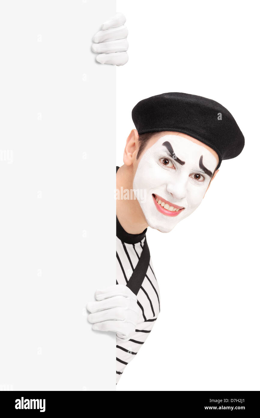 A smiling mime artist posing behind a blank panel, isolated on white ...