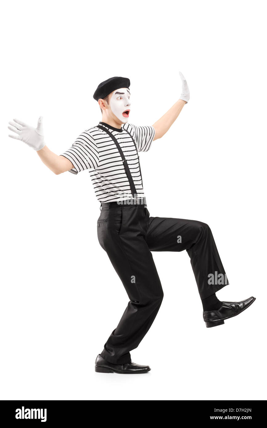 Full length portrait of a surprised mime artist gesturing with hands ...