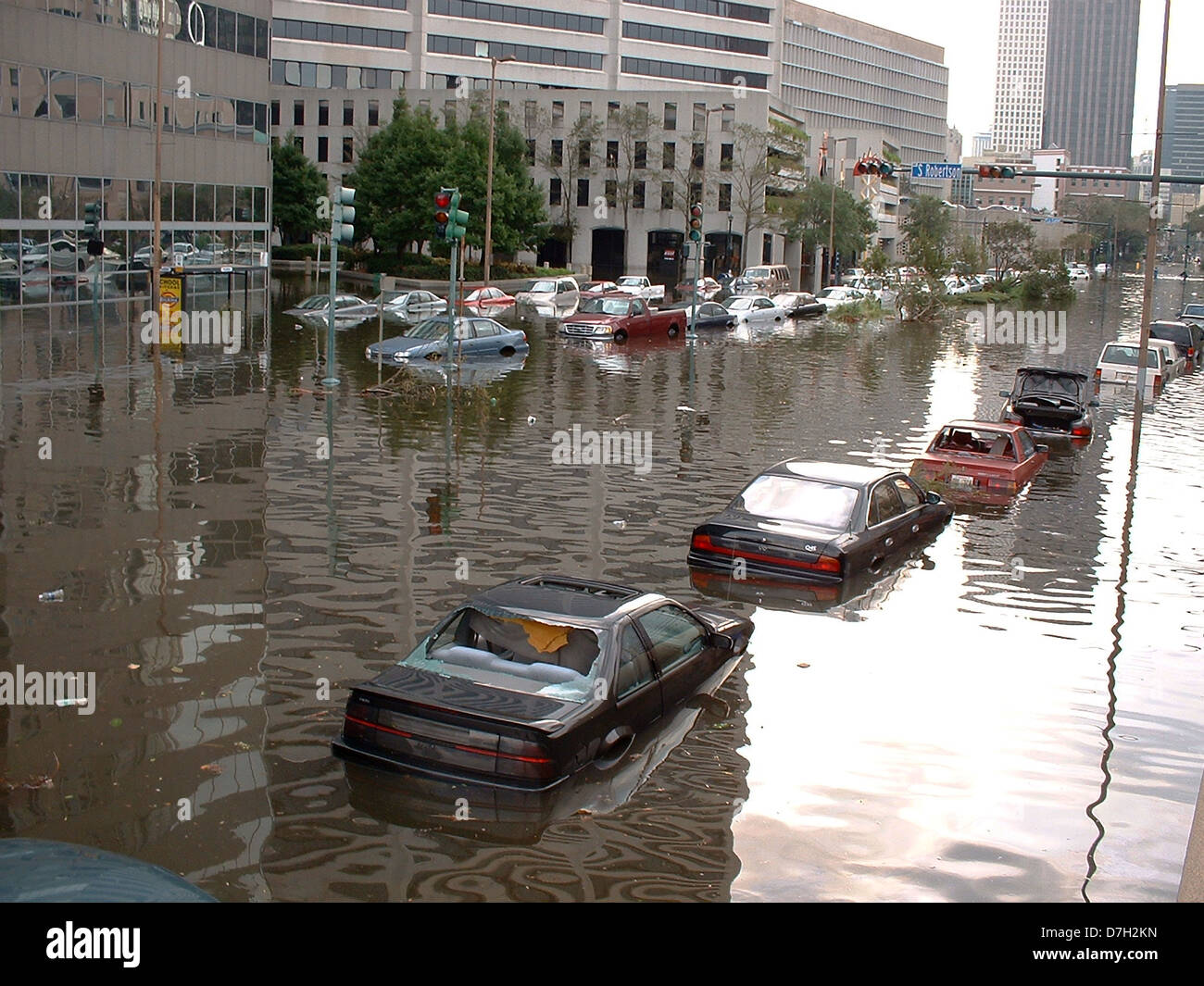 Cars submerged by flood waters scattered throughout the downtown area ...