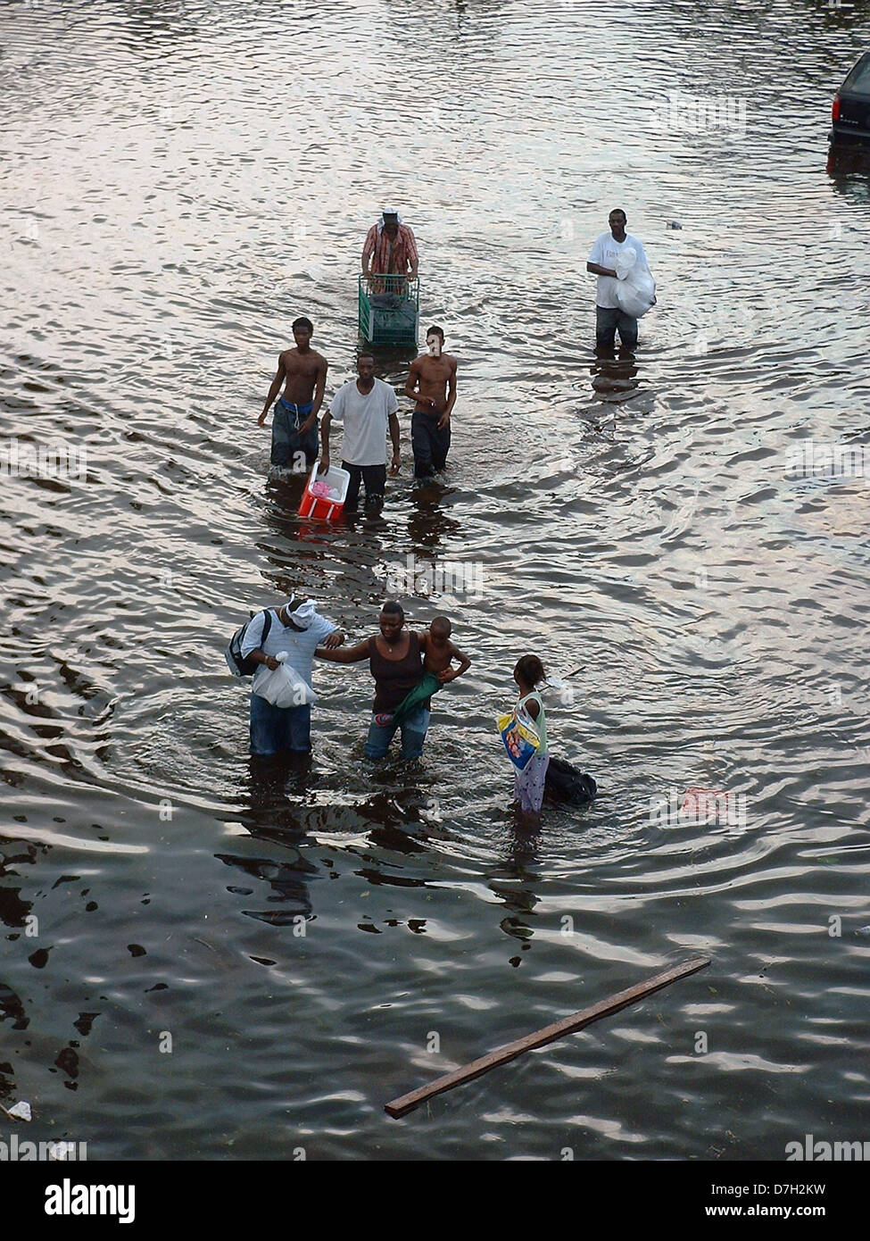 Aerial view of people trapped by flood waters trying to get to higher ...
