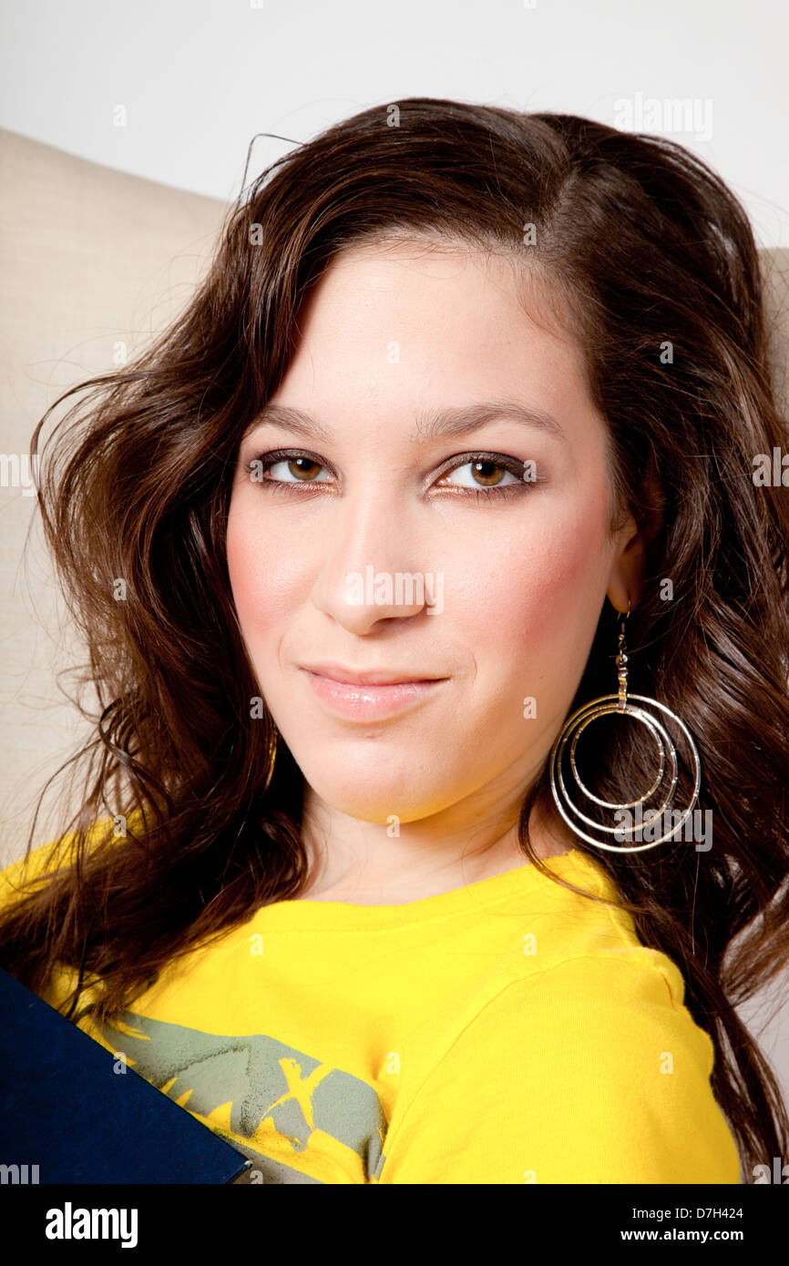 Cute White Girl In Yellow Shirt Looking At The Camera With A Friendly Pleased Smile Stock
