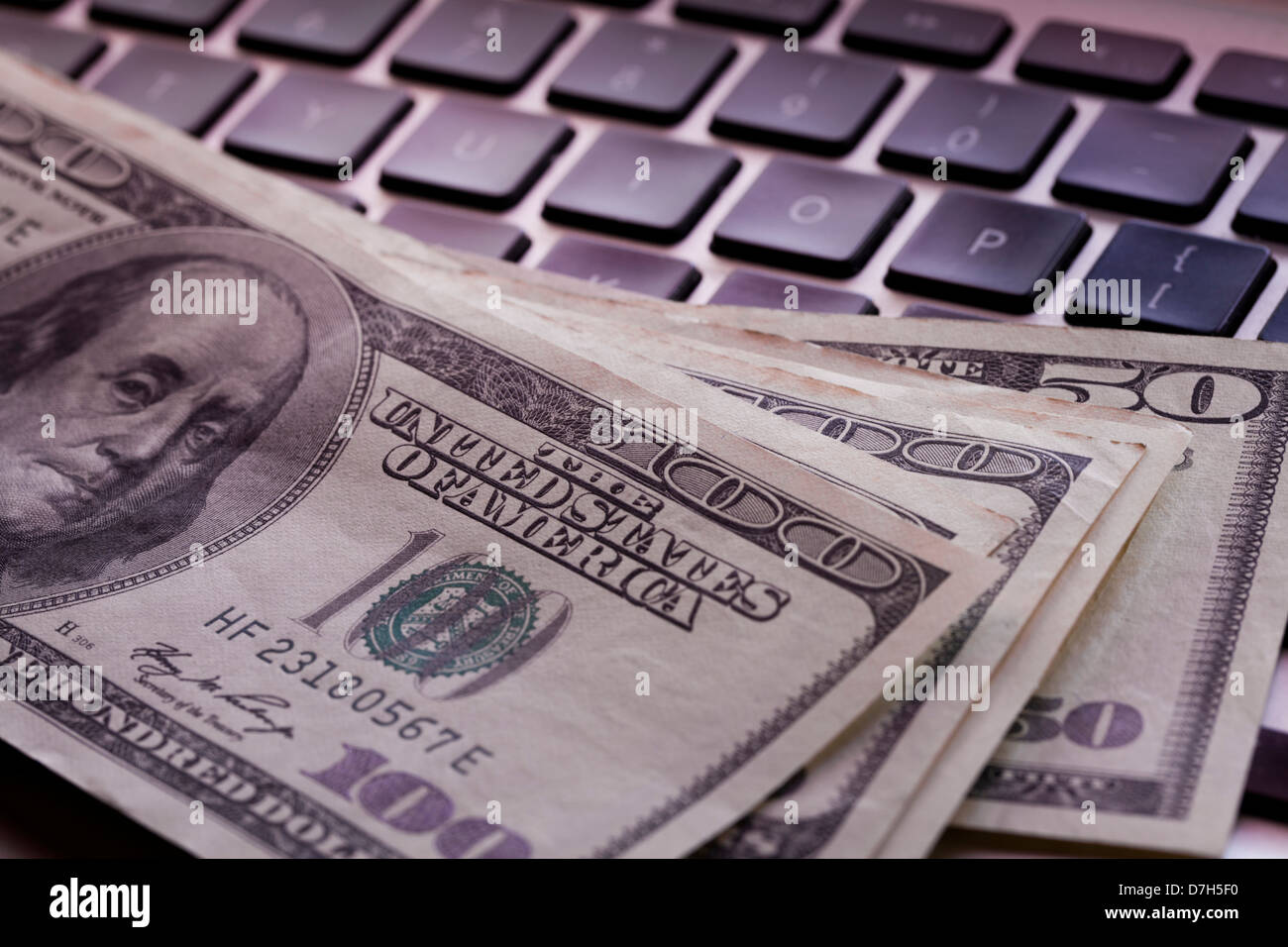 Money on computer keyboard Stock Photo - Alamy