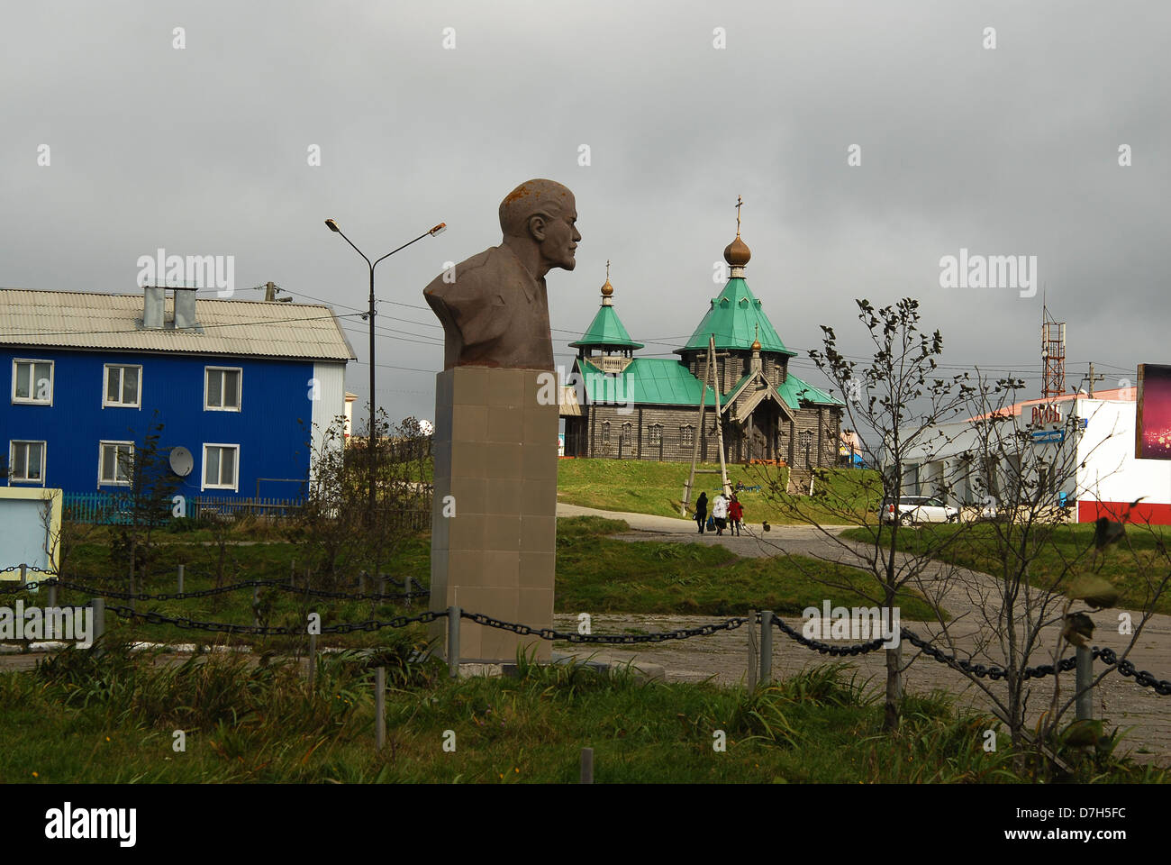 A Lenin's statue and Russian orthodox church in South Kurilsk. Kunashir ...