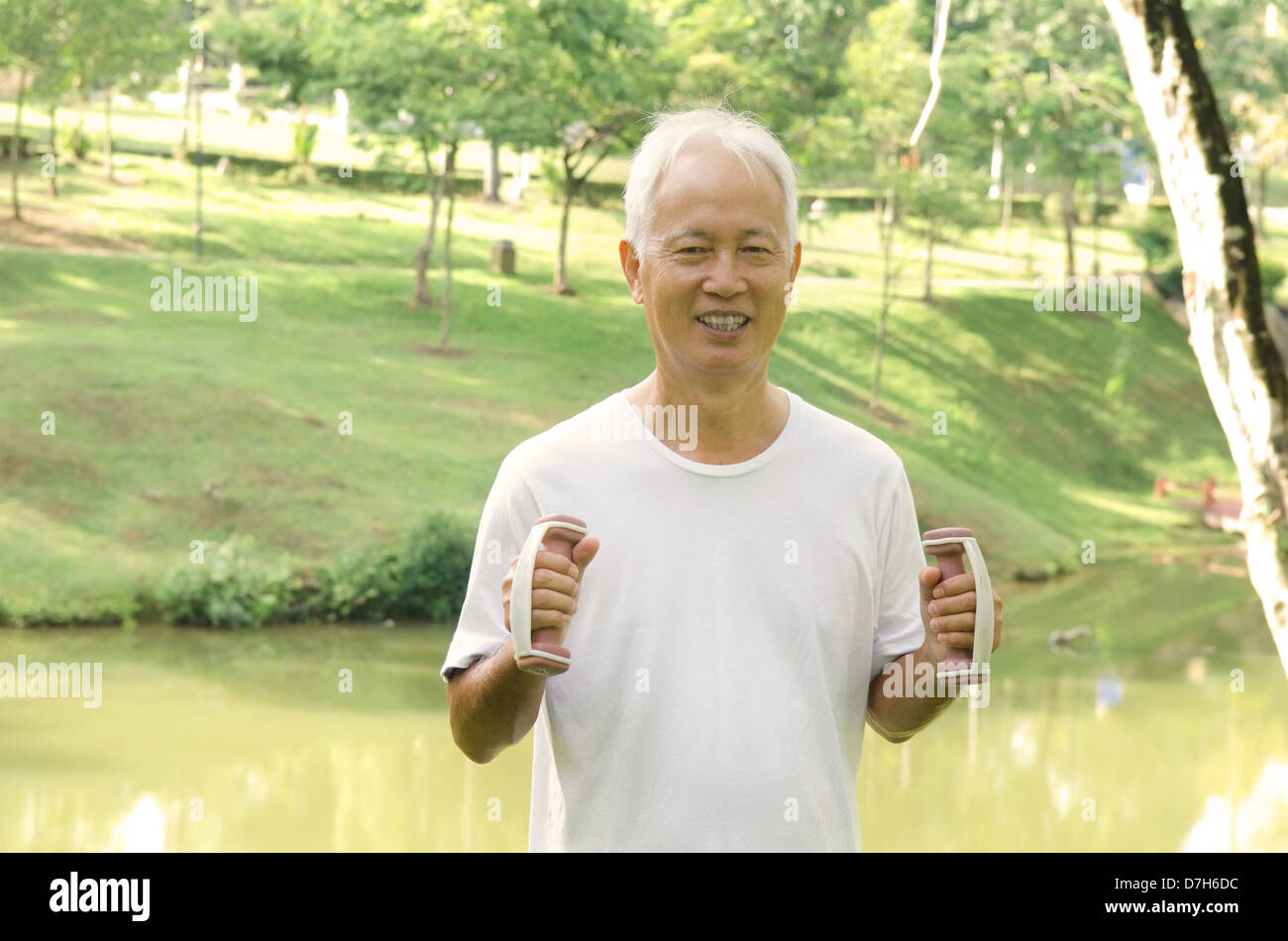 chinese Asian senior man healthy lifestyle working out on a park with a ...