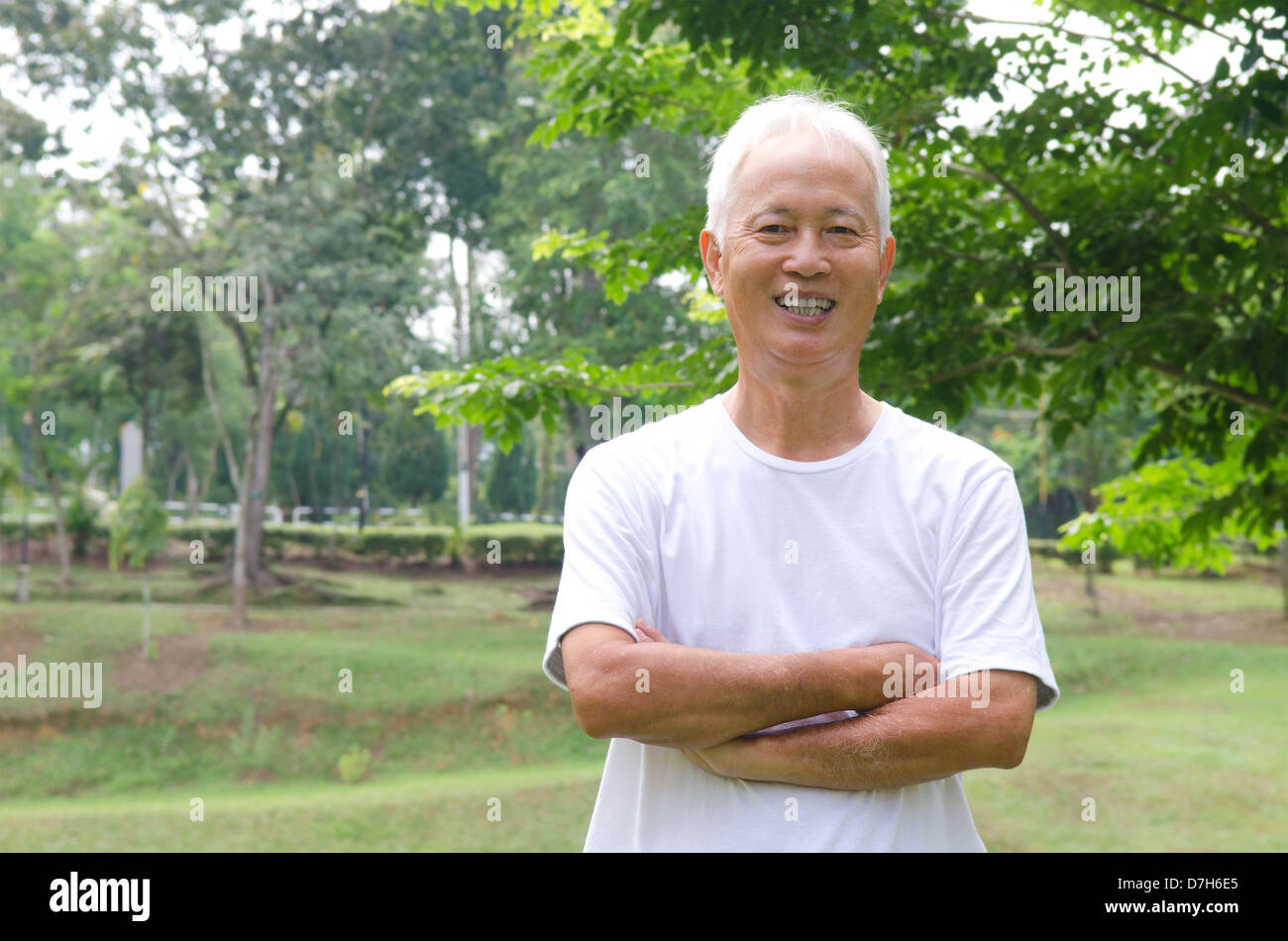 chinese asian senior male outdoor with green background Stock Photo - Alamy