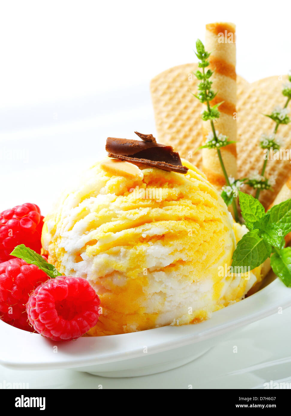 Scoop of ice cream with wafer sticks and raspberries Stock Photo - Alamy