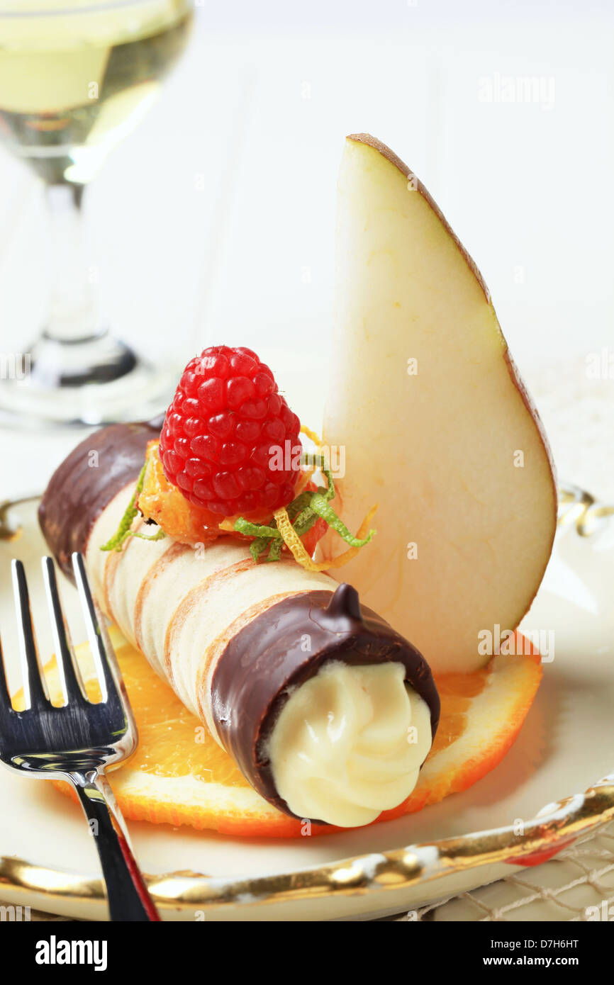 Chocolate dipped wafer tube filled with cream Stock Photo - Alamy