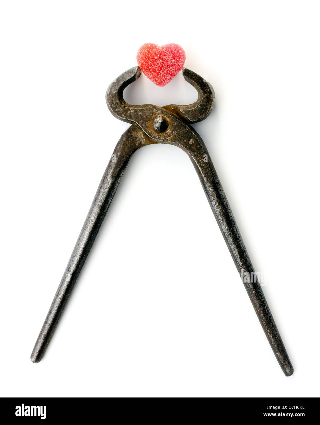 heart under pressure with tongs on white background Stock Photo - Alamy