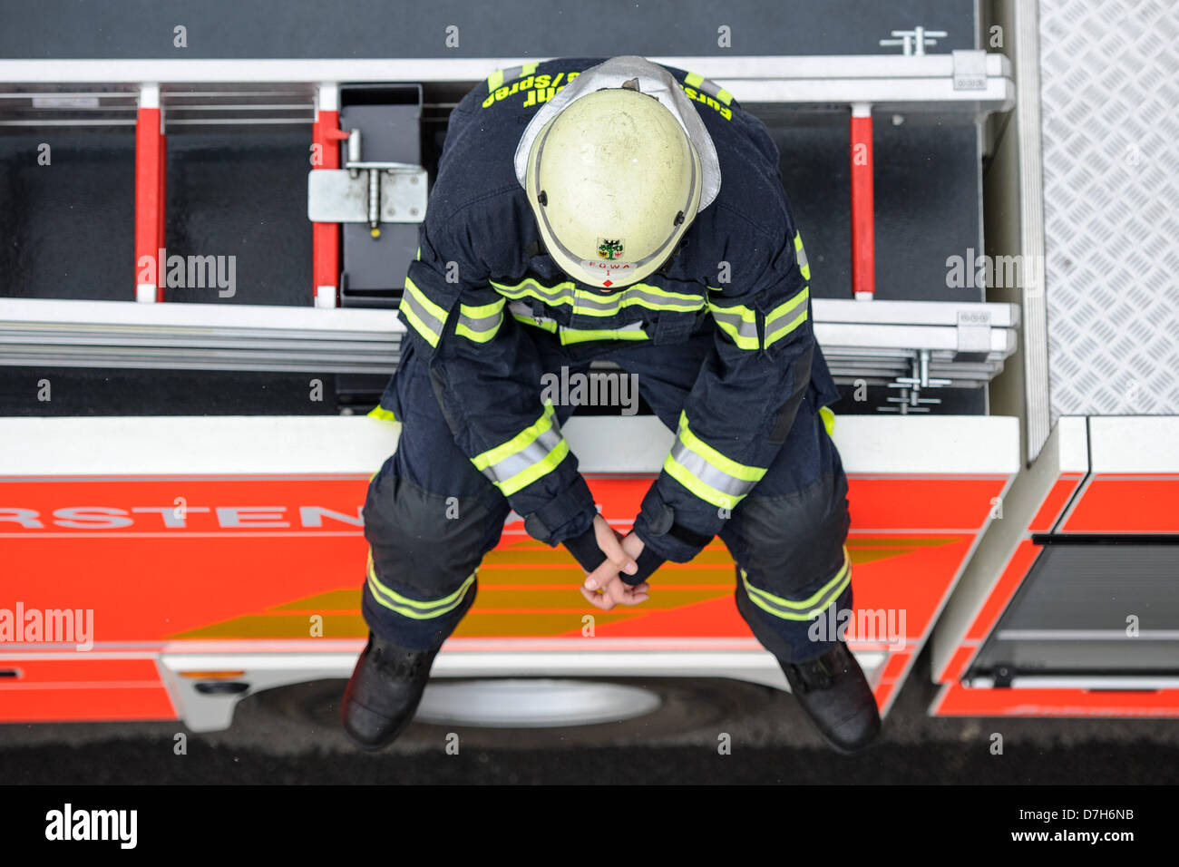A firefighter sitting on top of a fire engine. Photo: Robert ...