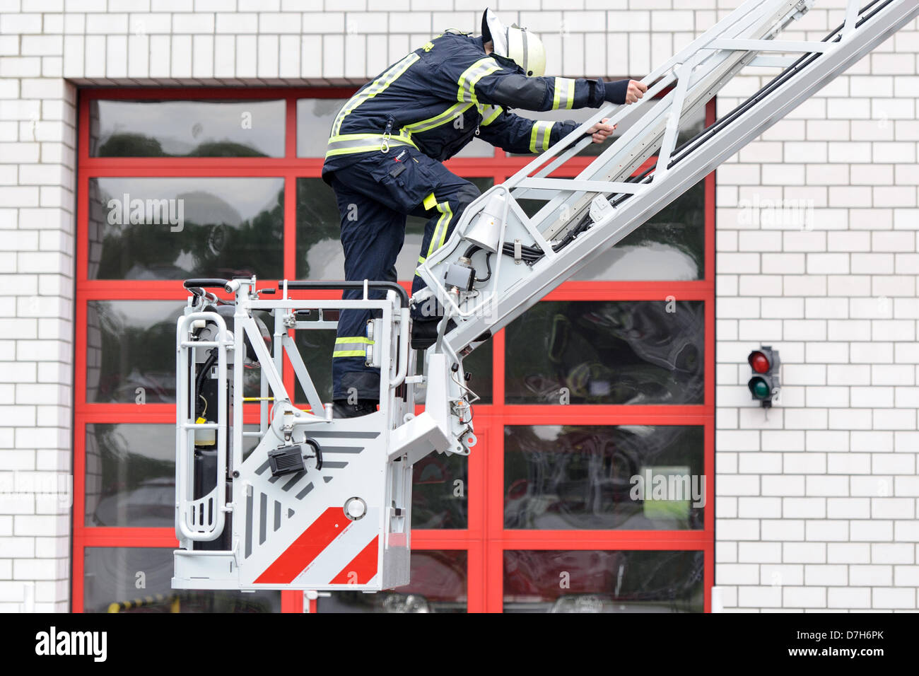 A firefighter climbs a ladder. Photo: Robert Schlesinger Stock Photo ...