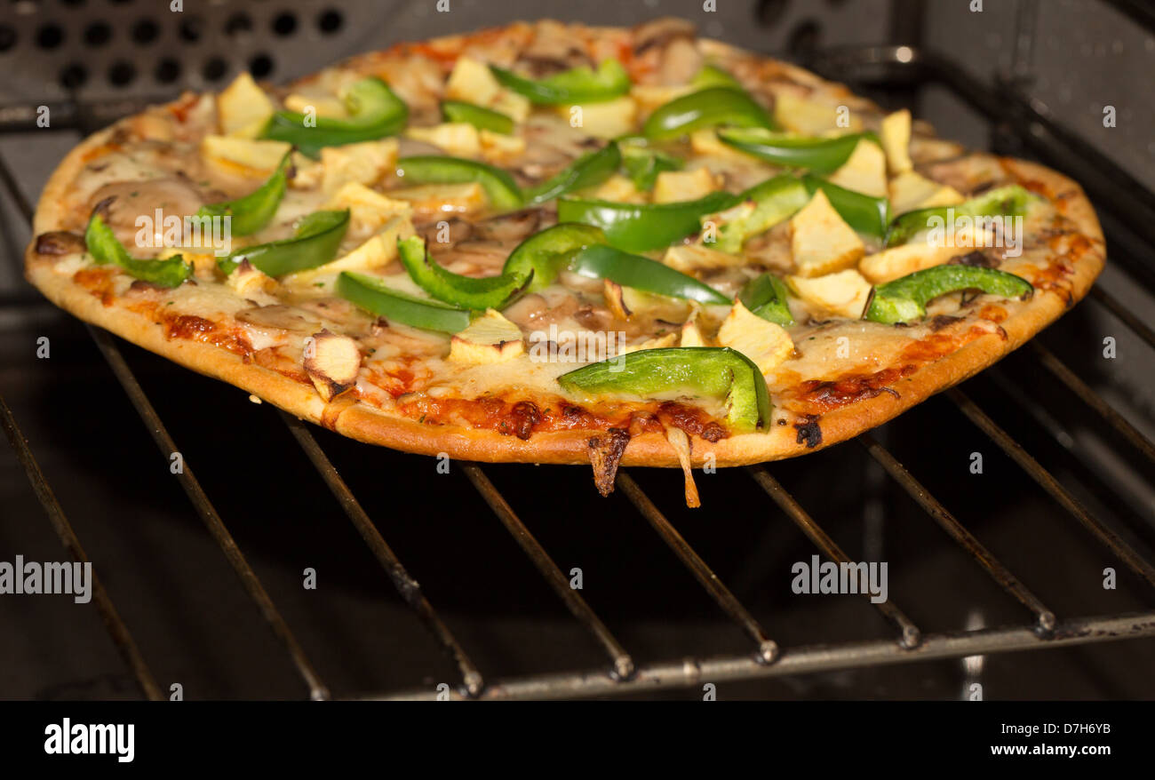 Closeup of entire cooked pizza in oven, horizontal composition Stock ...