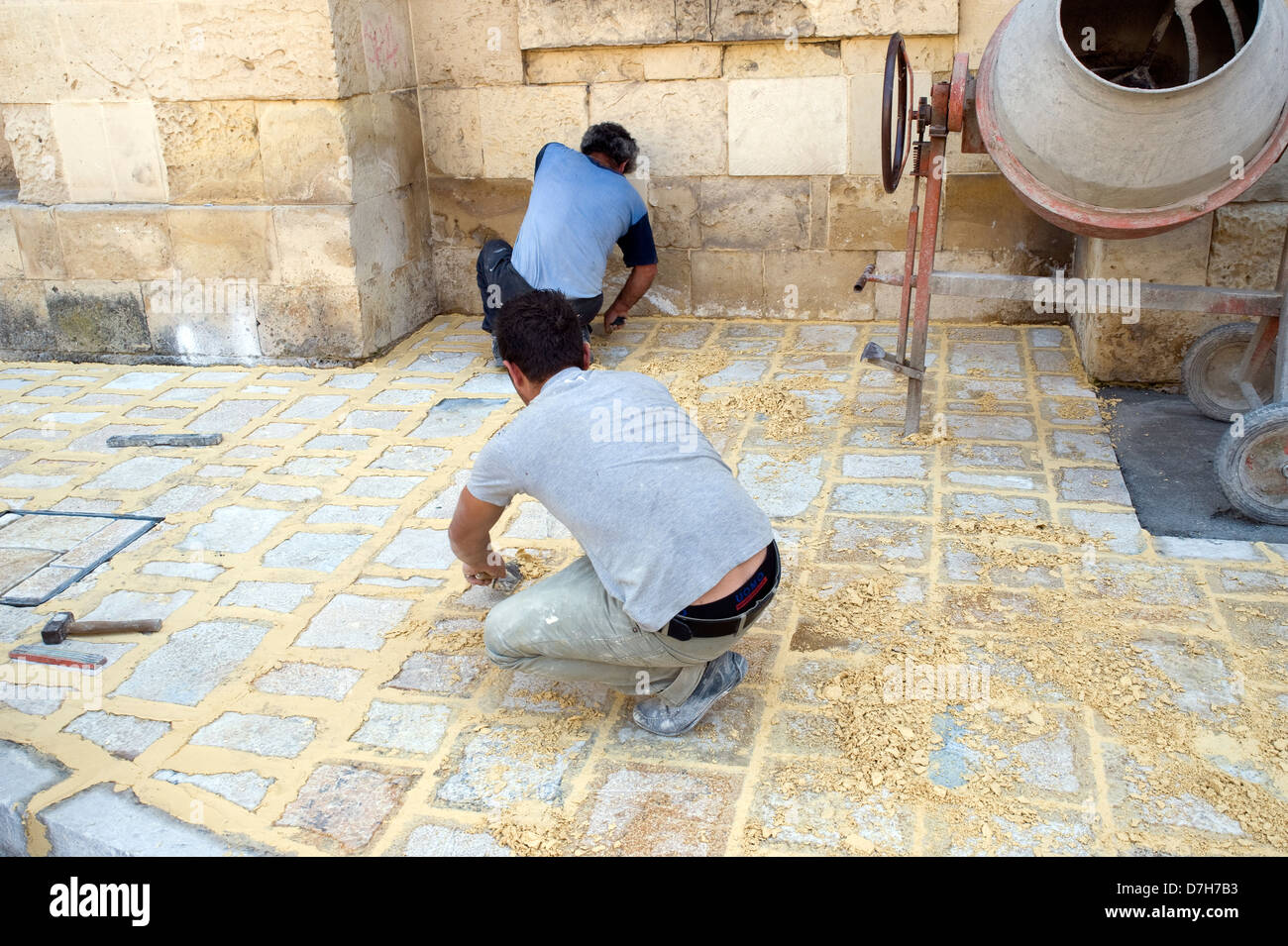 Builders pointing paving, Corfu Town, Greece Stock Photo - Alamy