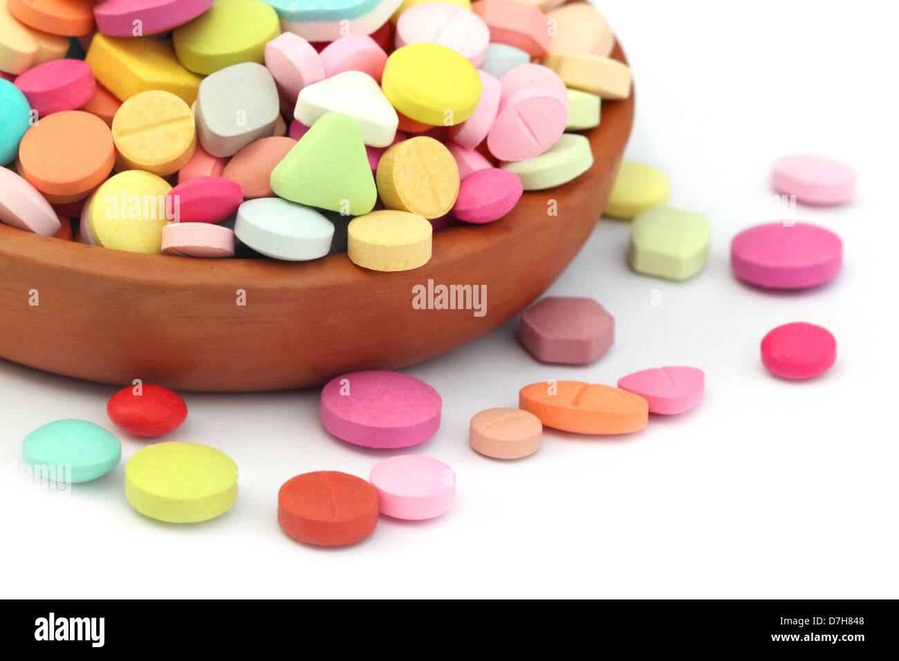 Colorful tablets spilled from a clay pottery Stock Photo - Alamy