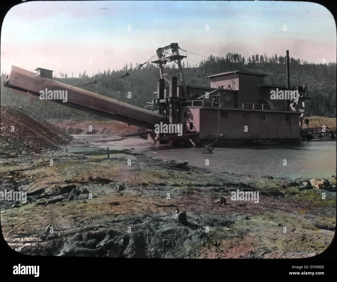 This historical image captures a scene of gold dredging from Oregon ...