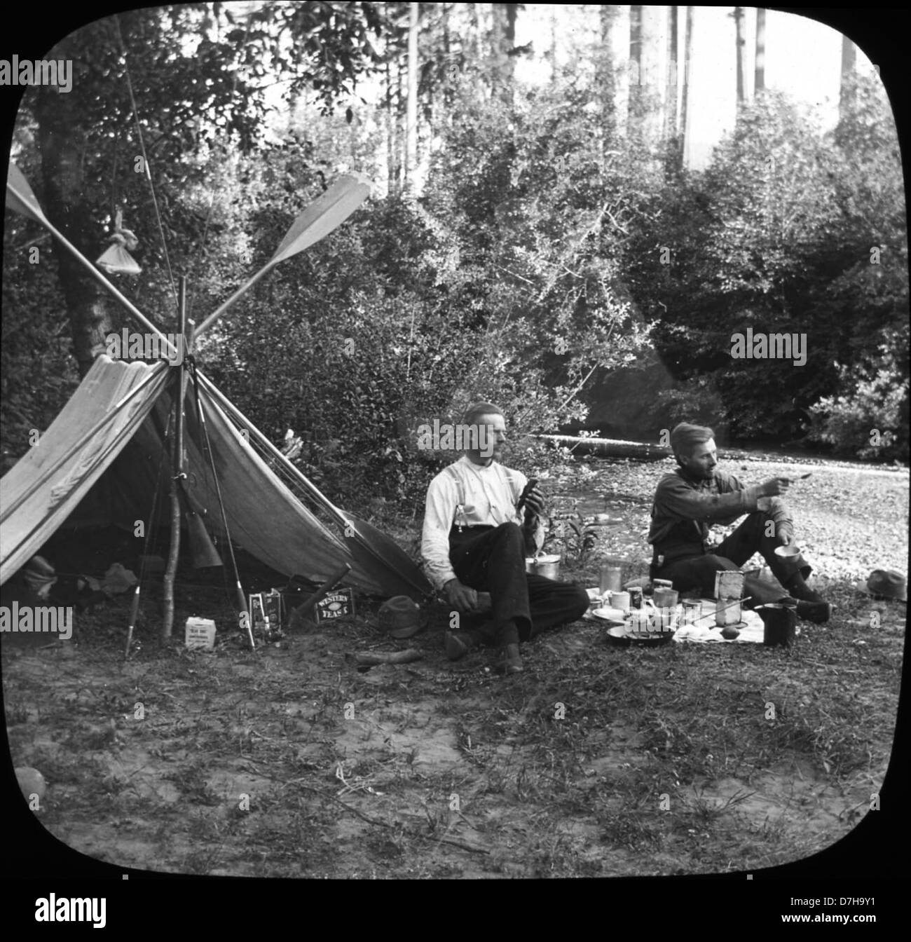 Herman Bohlman and William L. Finley are pictured at a campsite along a ...