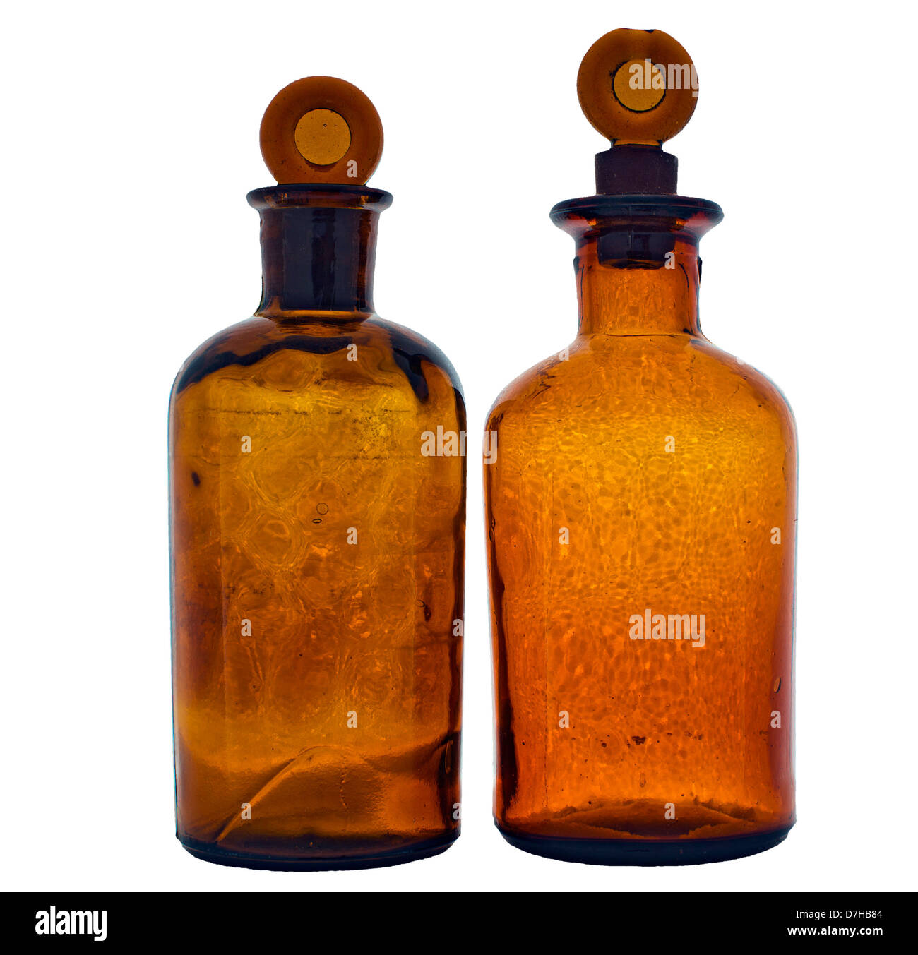 Two laboratory bottles, amber glass. Backlit. Isolated on white ...