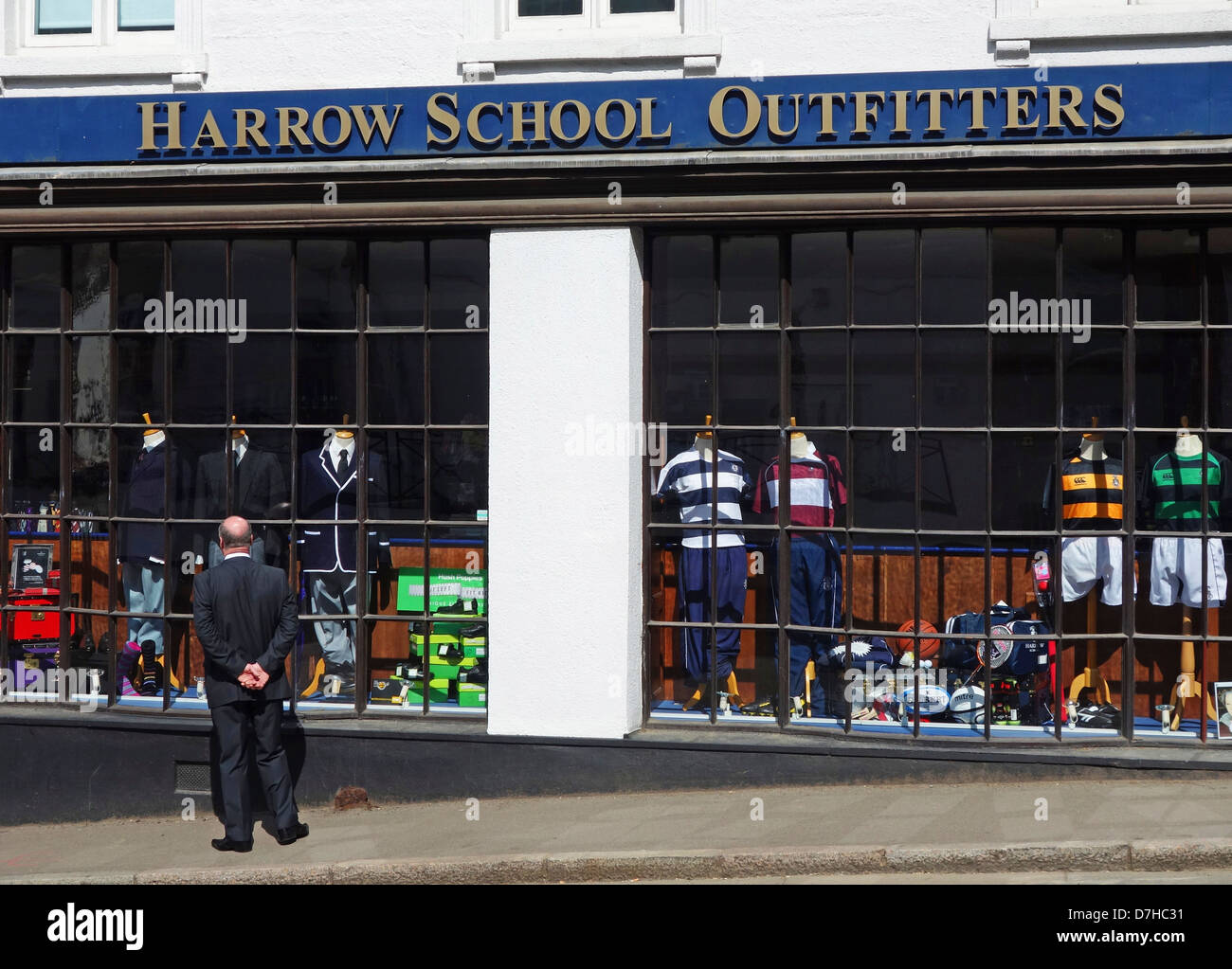 A gentleman looking in the window of the Harrow school shop, Harrow on ...