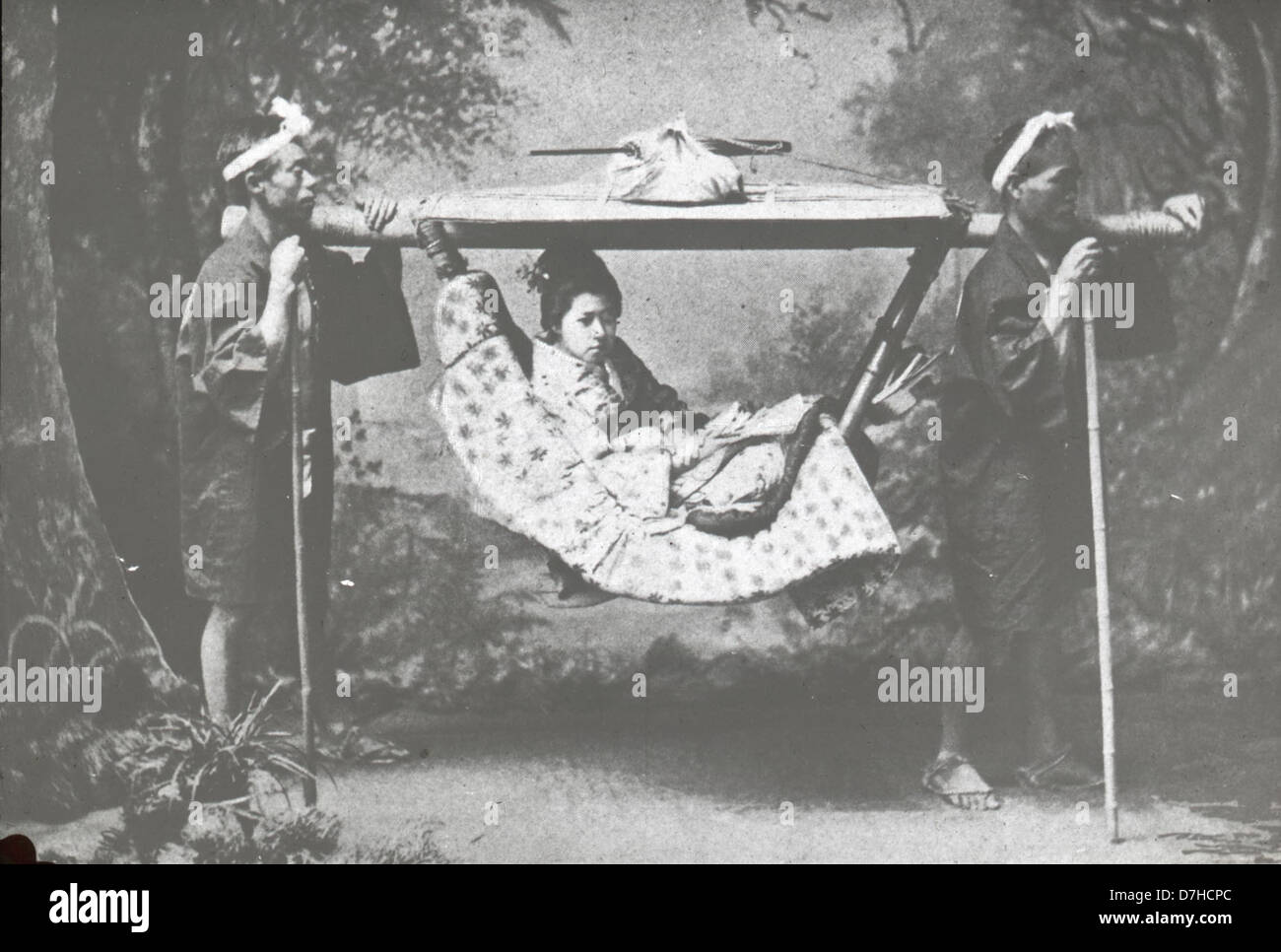 A historical photograph of Kago bearers in Japan, depicting the ...