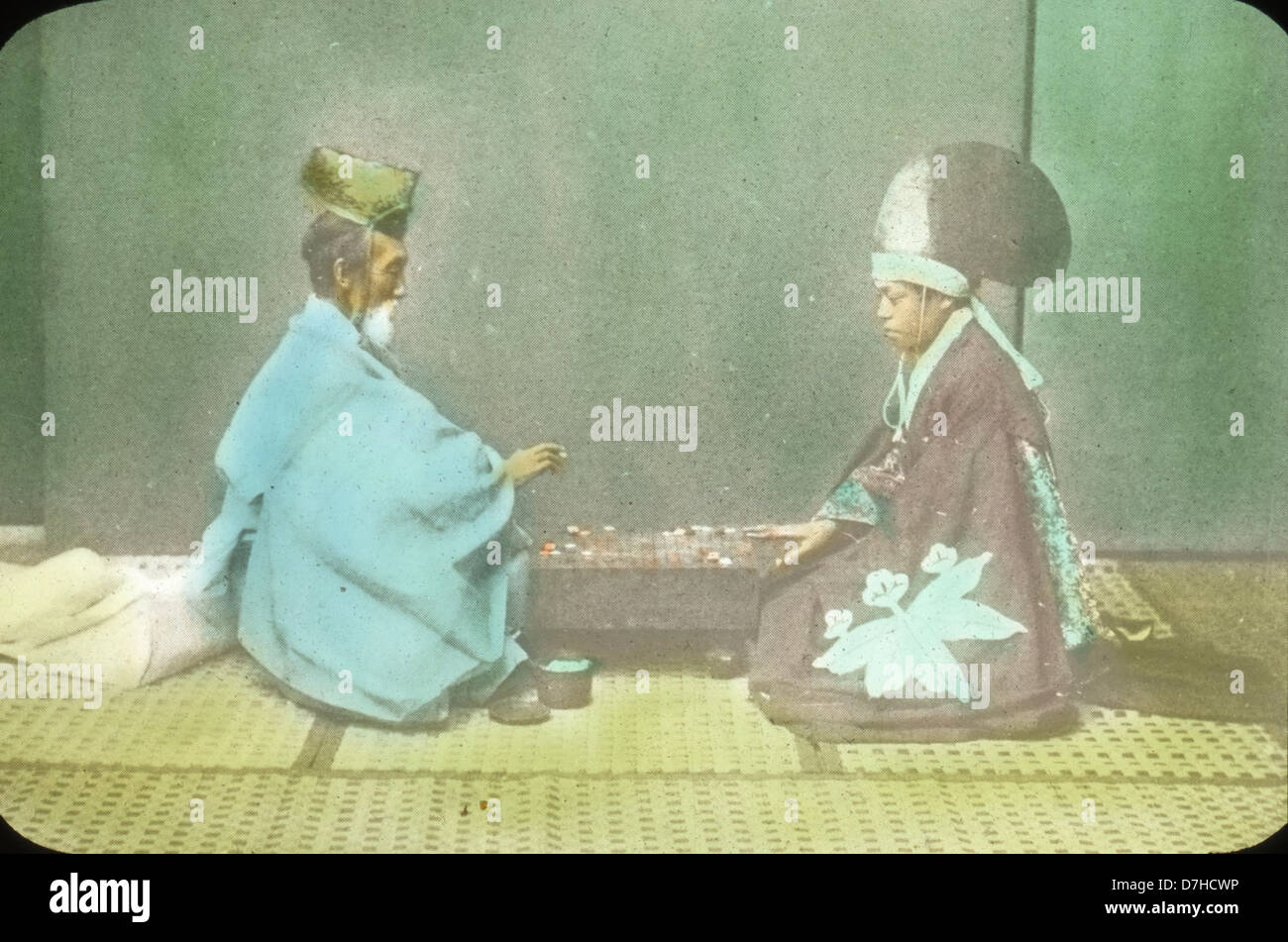 This image captures a traditional game of Go, a strategy board game, in ...