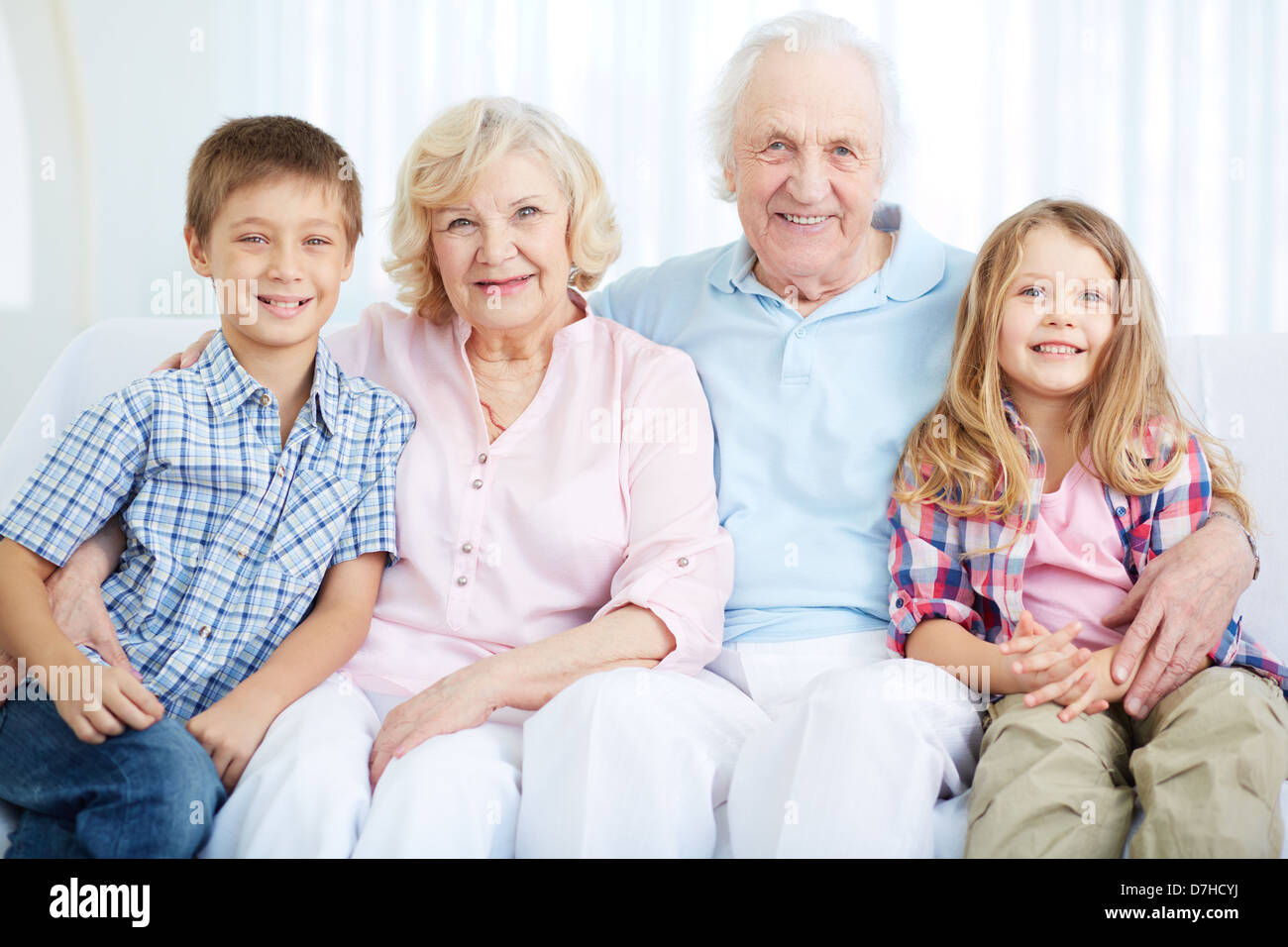 Portrait of happy grandparents with two grandchildren having rest at ...