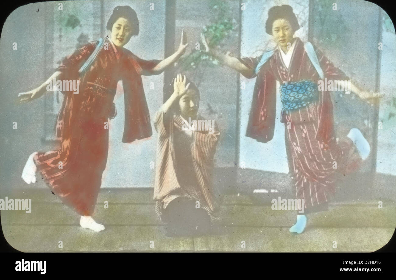 This photograph features a geisha from Japan, performing a traditional ...