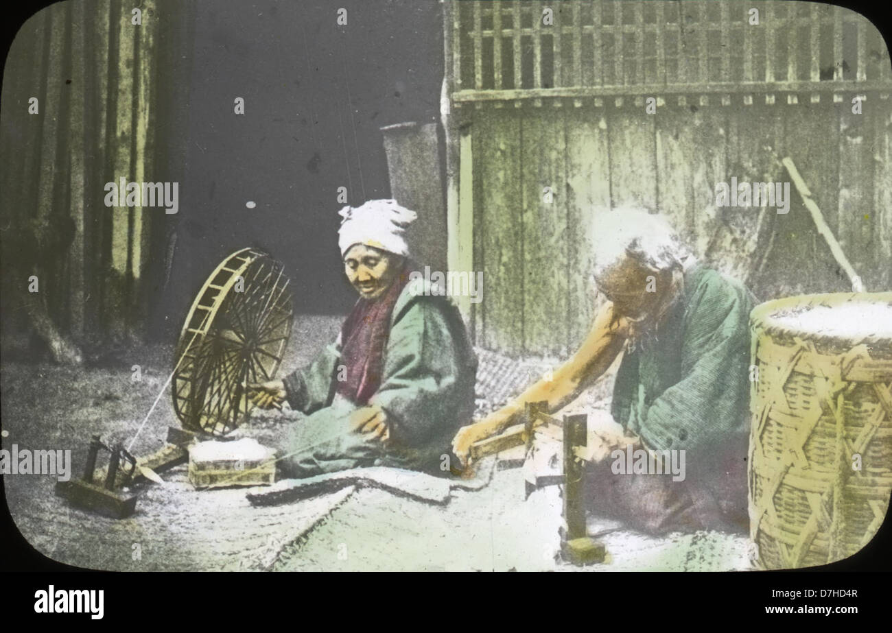 This image captures a traditional cotton spinning process, showcasing ...