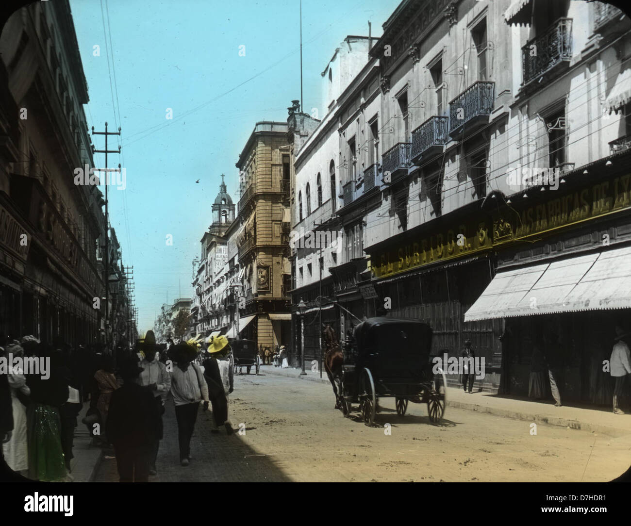 This image depicts a bustling street scene in the City of Mexico ...