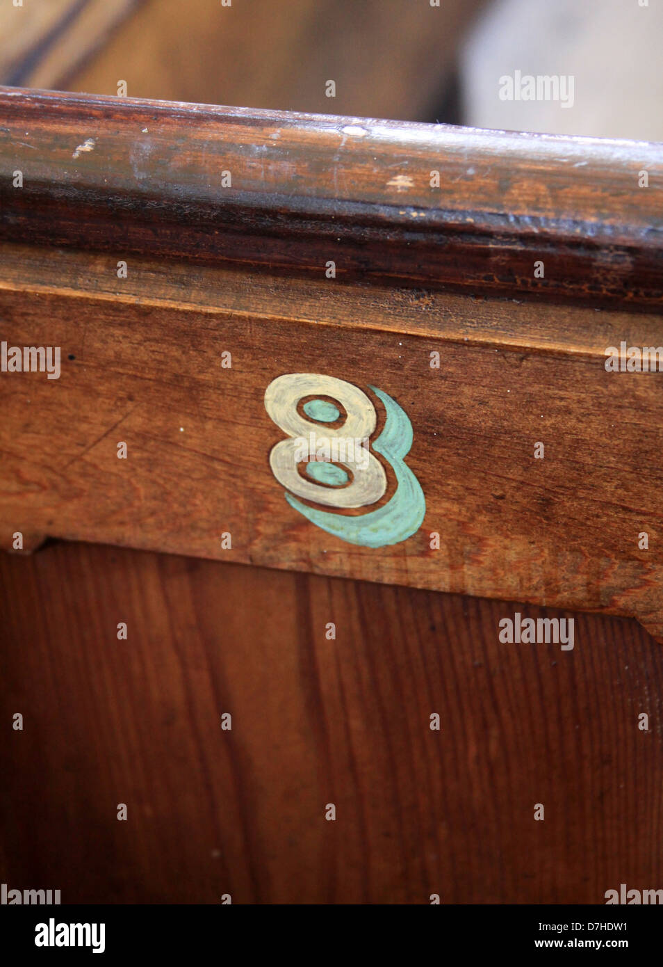 Detail of hand painted Number 8 on a Welsh Chapel pitch pine pew Stock ...