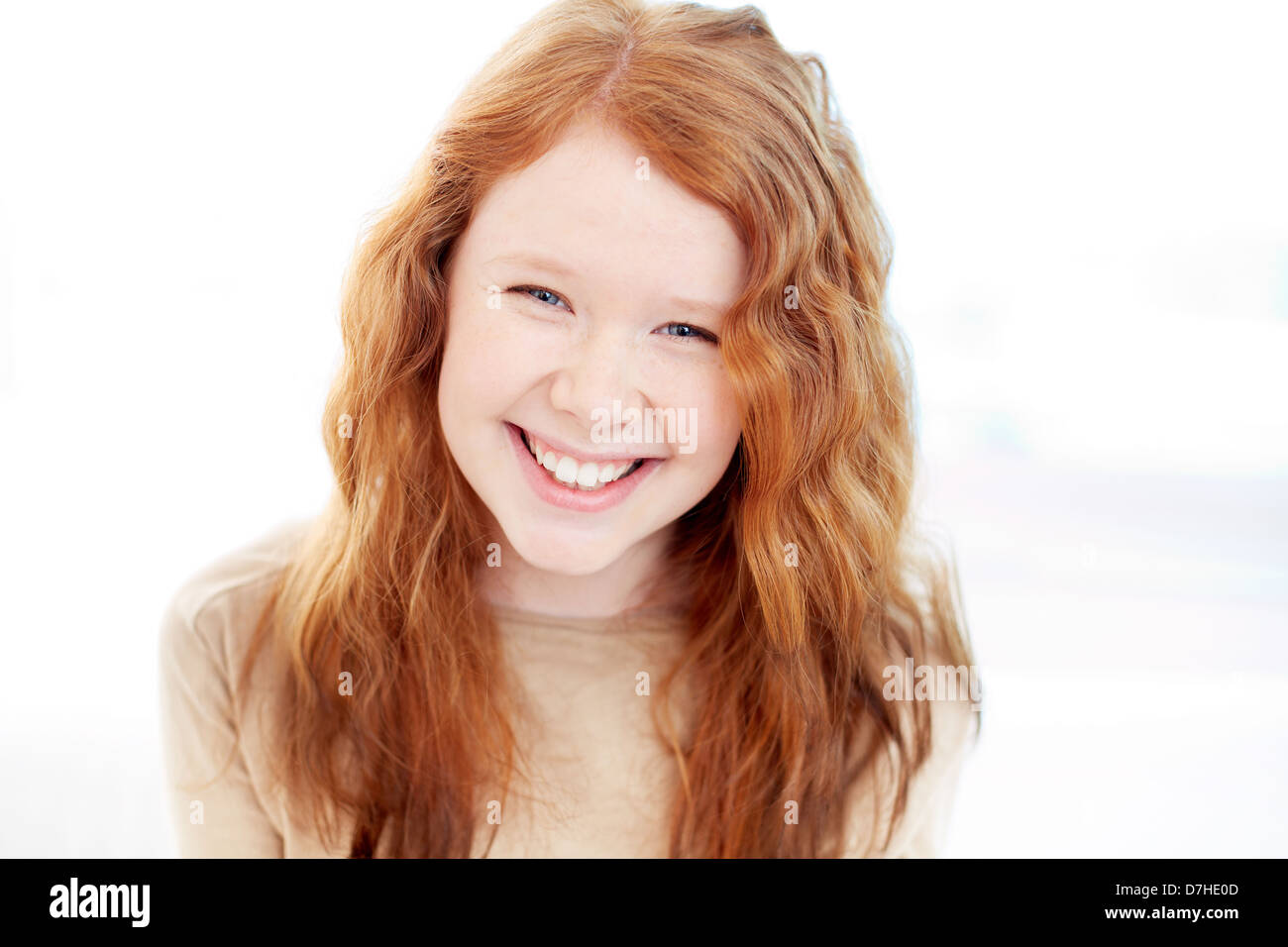 Teenage girl with wavy ginger hair looking at camera with smile Stock ...