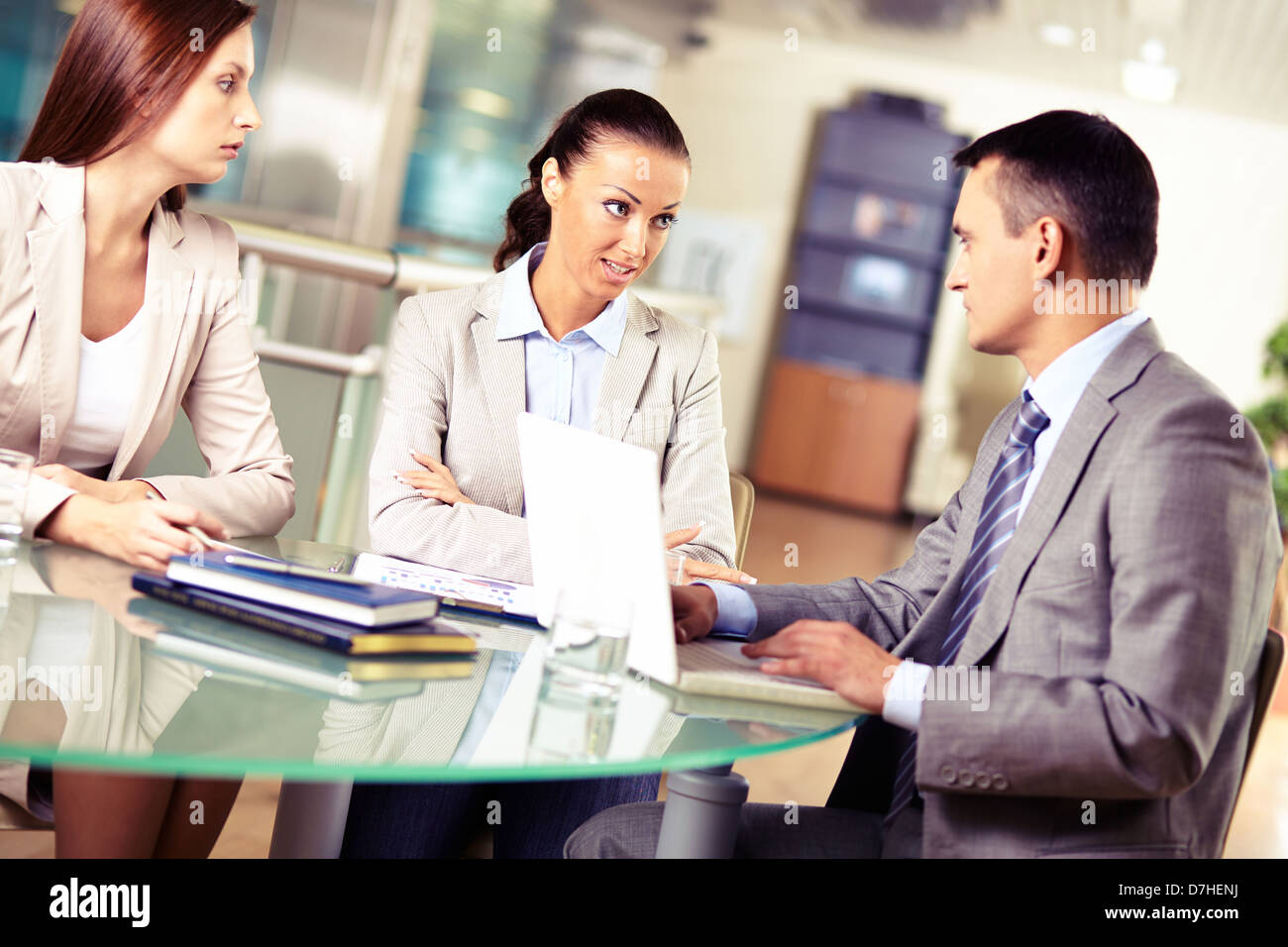Group of business partners interacting at meeting in office Stock Photo ...