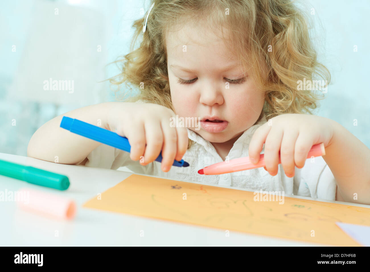 Pretty child having fun drawing at kindergarten Stock Photo - Alamy