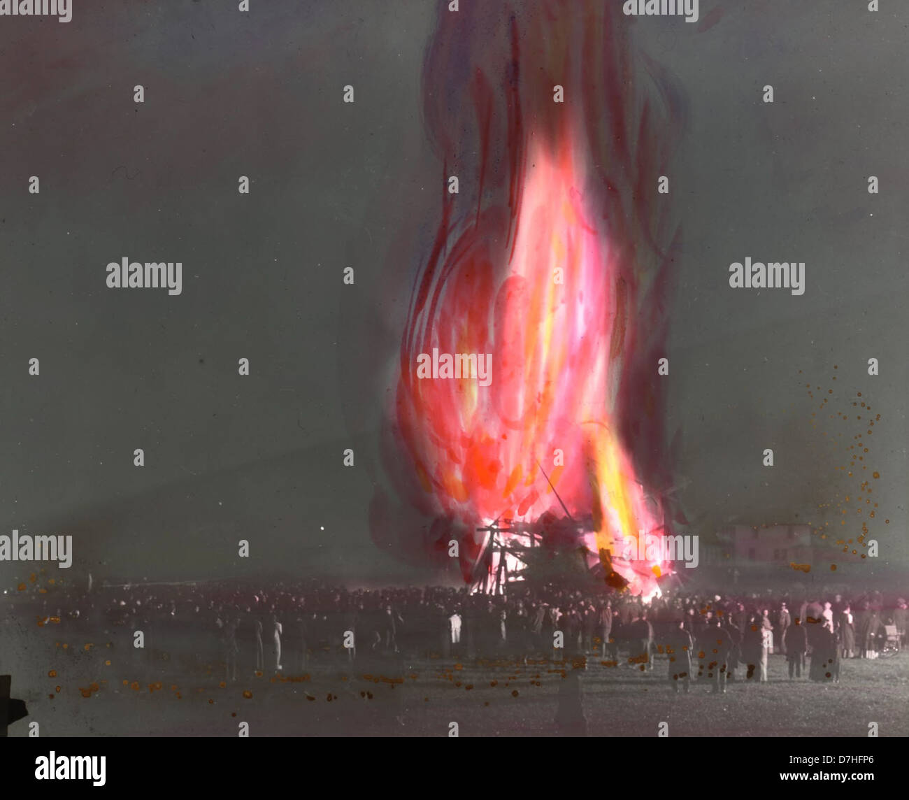 The image depicts a bonfire, a large fire used traditionally for warmth ...