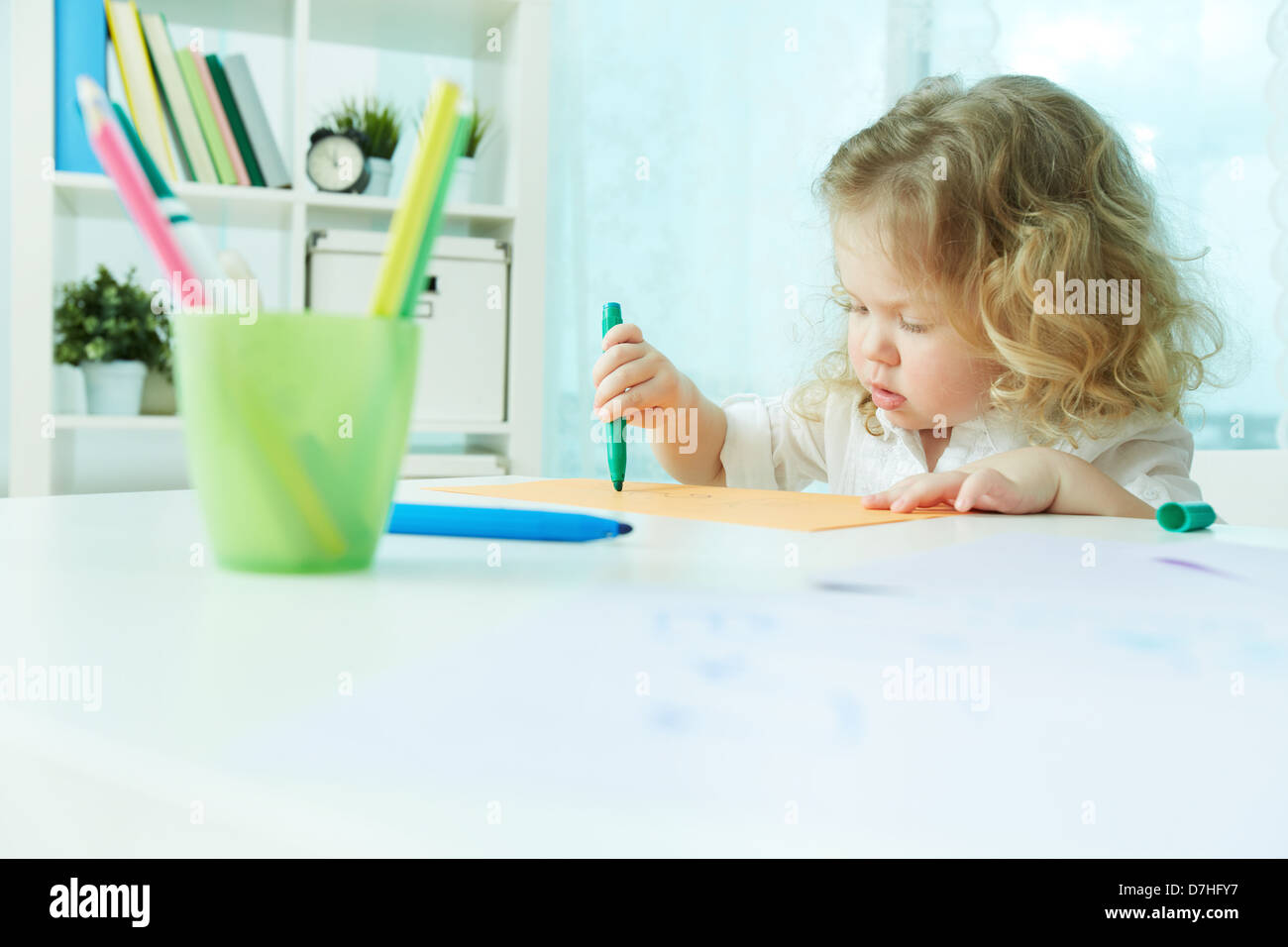 Diligent preschool child drawing at home Stock Photo - Alamy